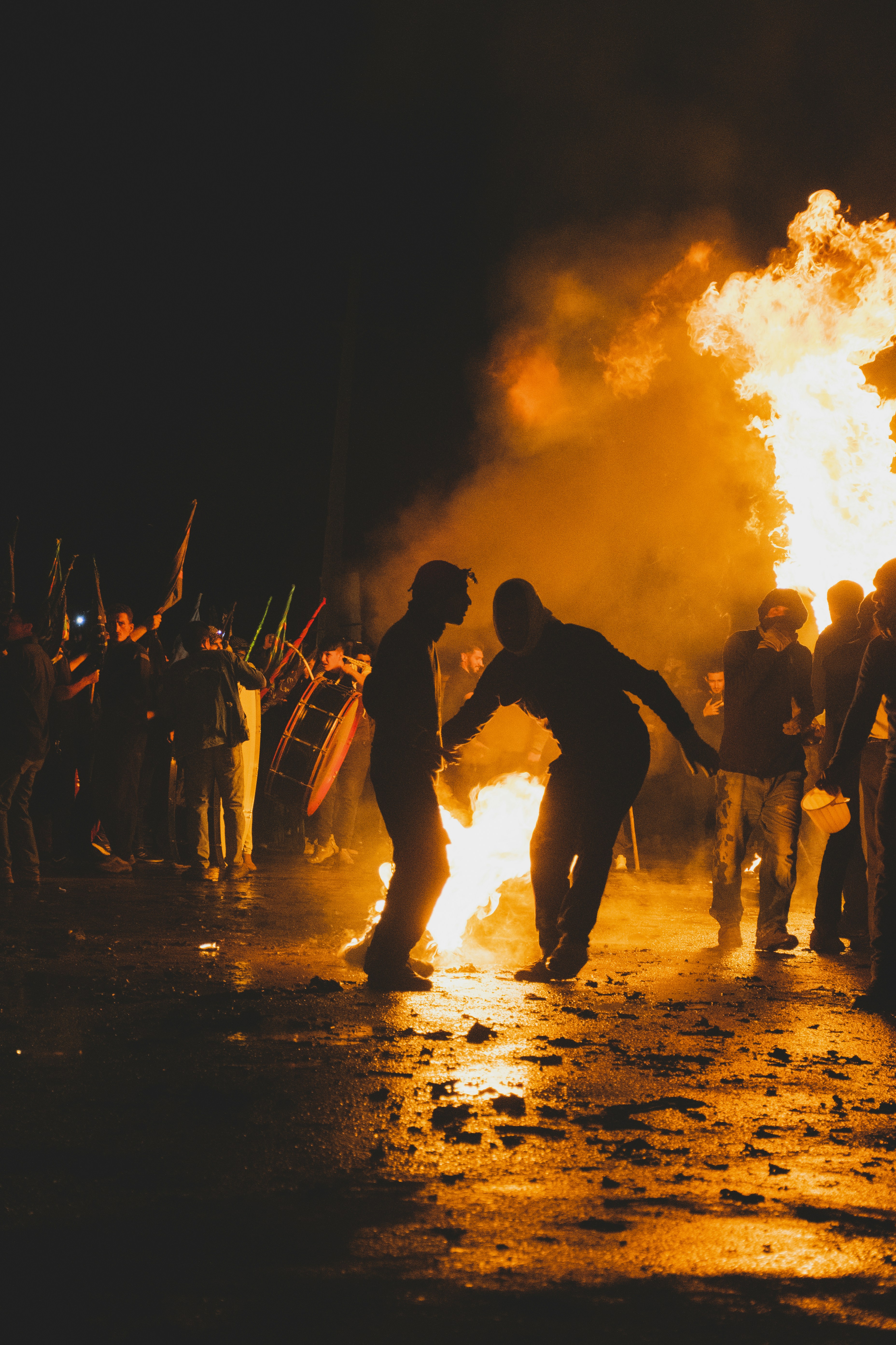 A group of people standing around a fire photo – Free Shishavan Image ...