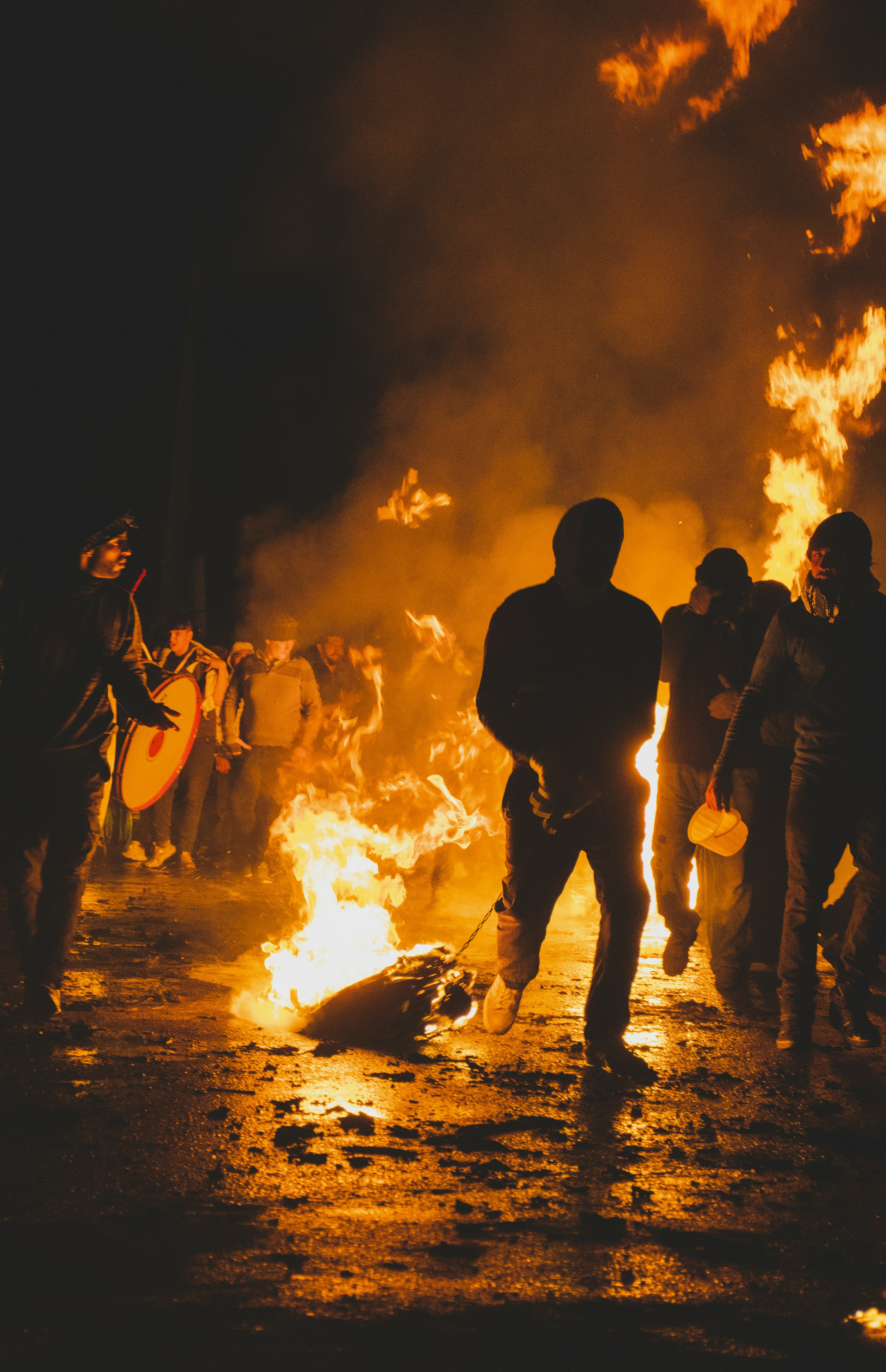 A group of people standing around a fire photo – Free Wallpaper Image ...
