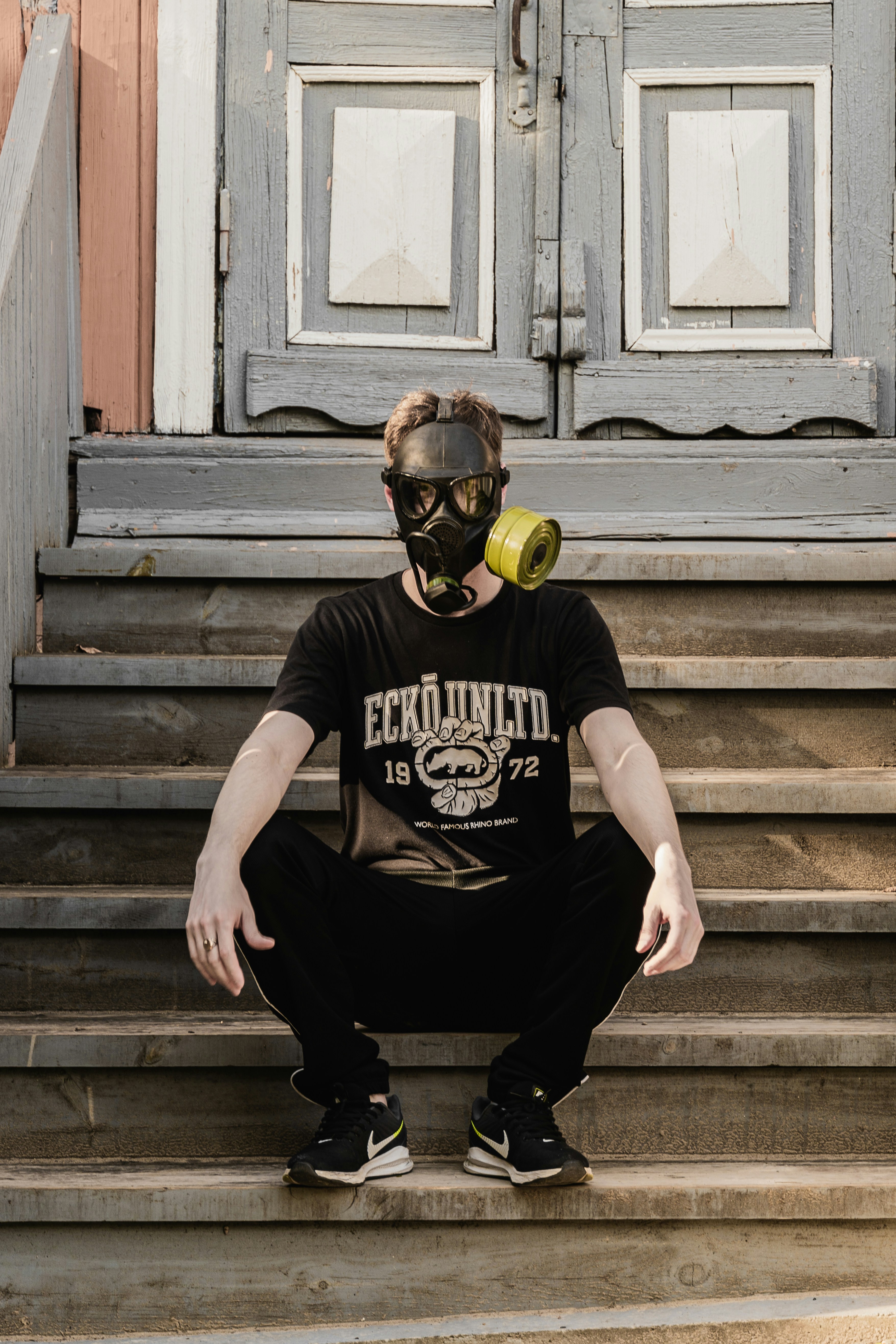 A man with a gas mask sitting on some steps photo – Free Dzerzhinskogo ...