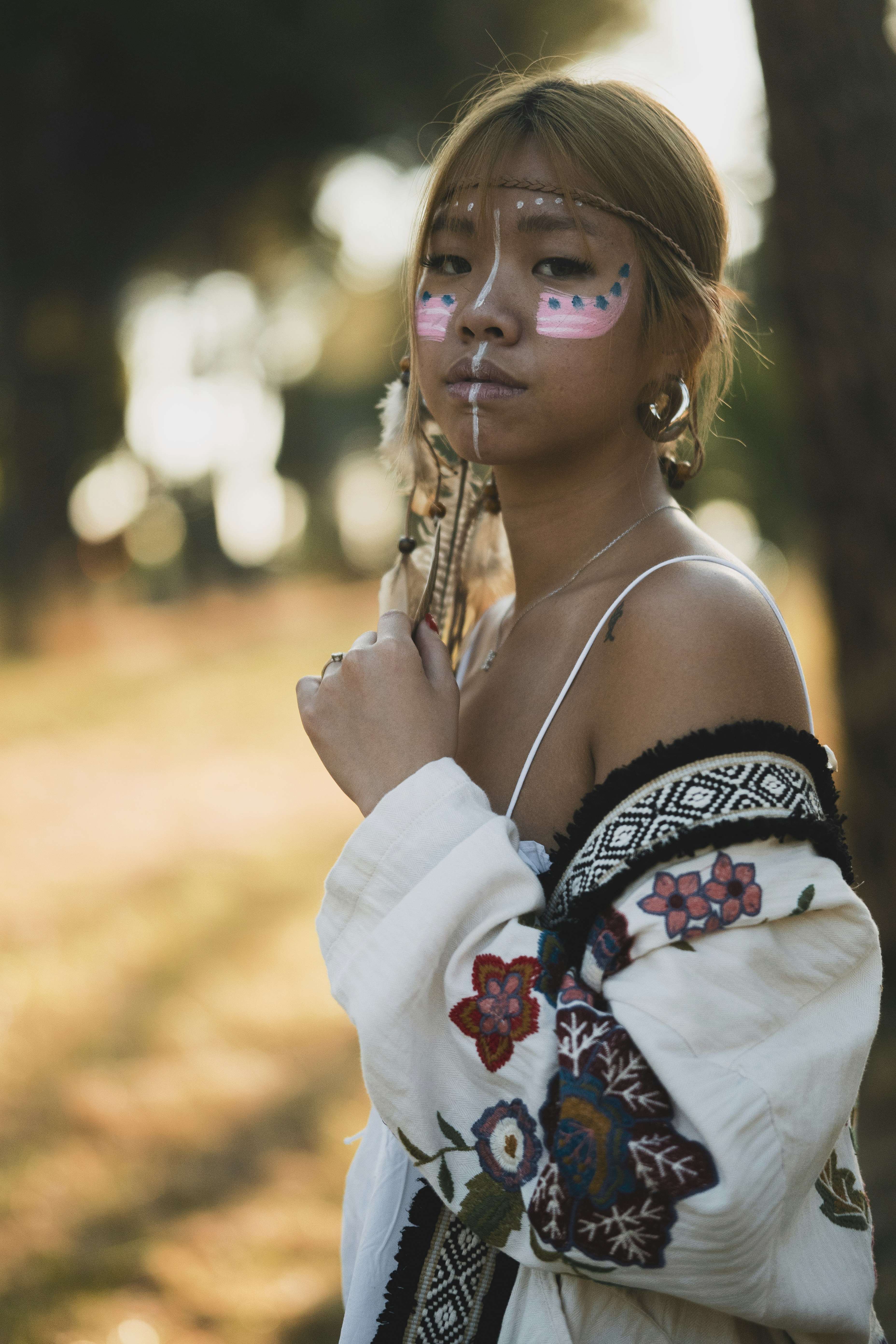 Face Paint and Frayed Threads: A Portrait in Golden Light
