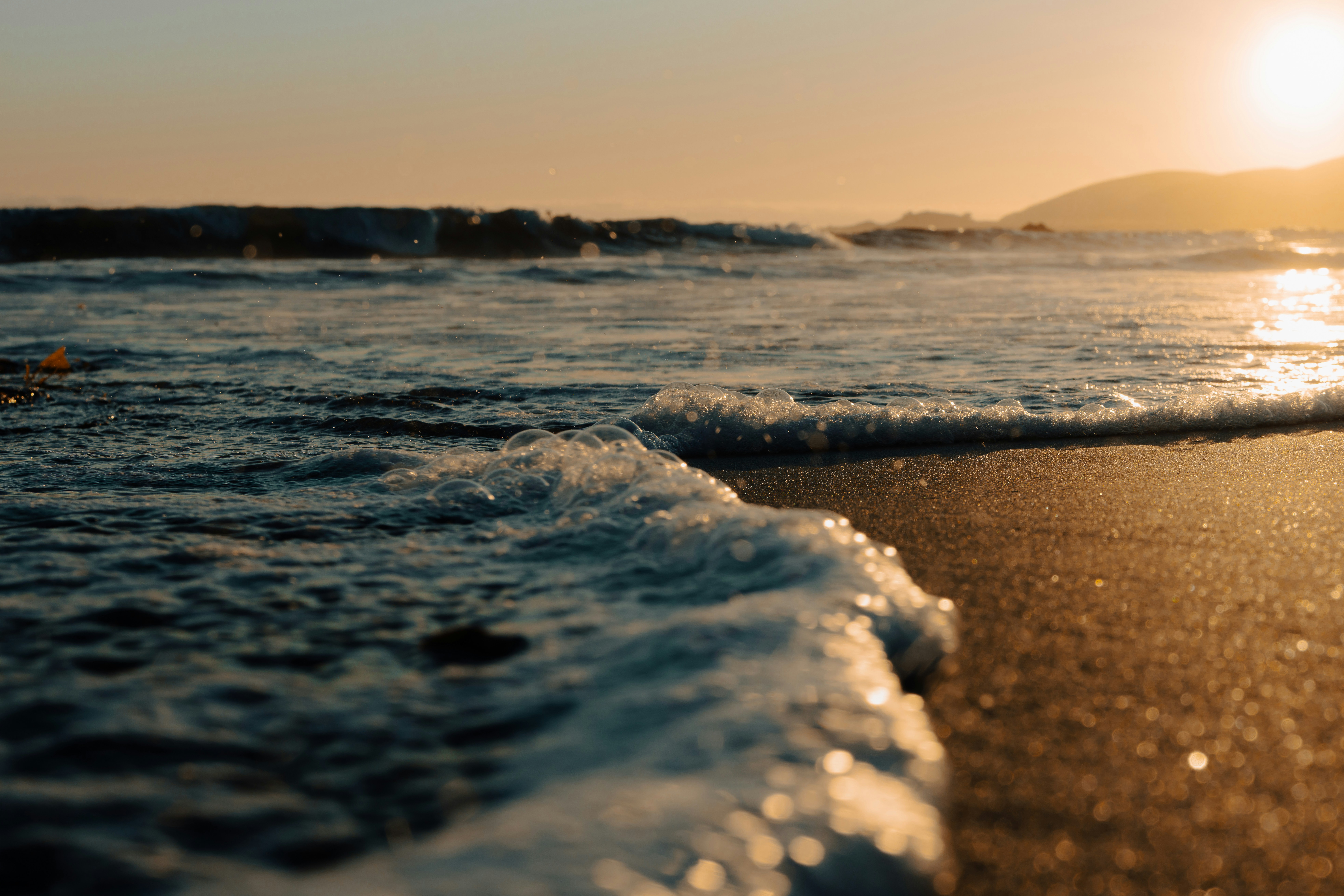 The sun is setting over the water on the beach photo – Free Cayucos ...