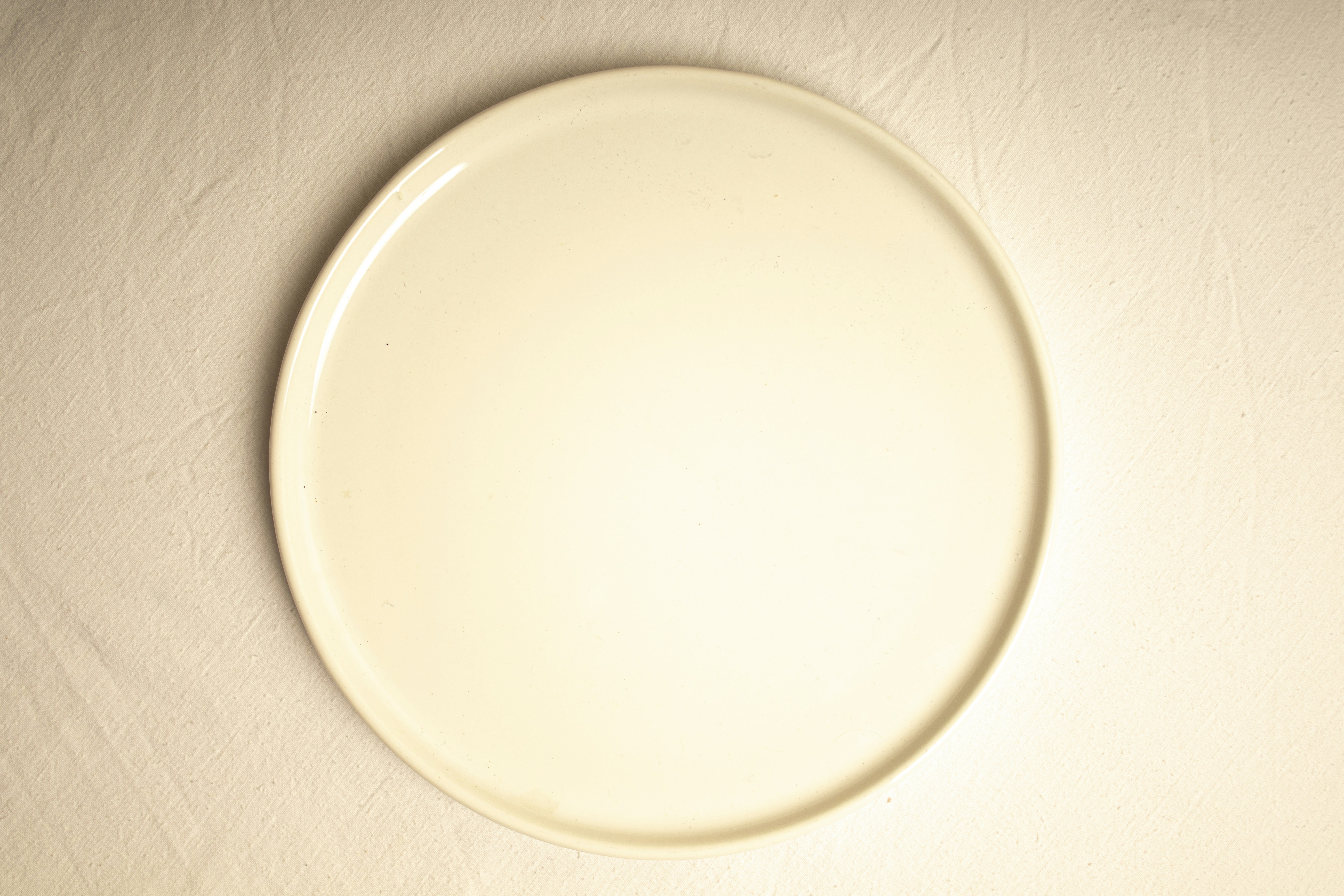 A white plate sitting on top of a table photo – Free Plate Image on ...