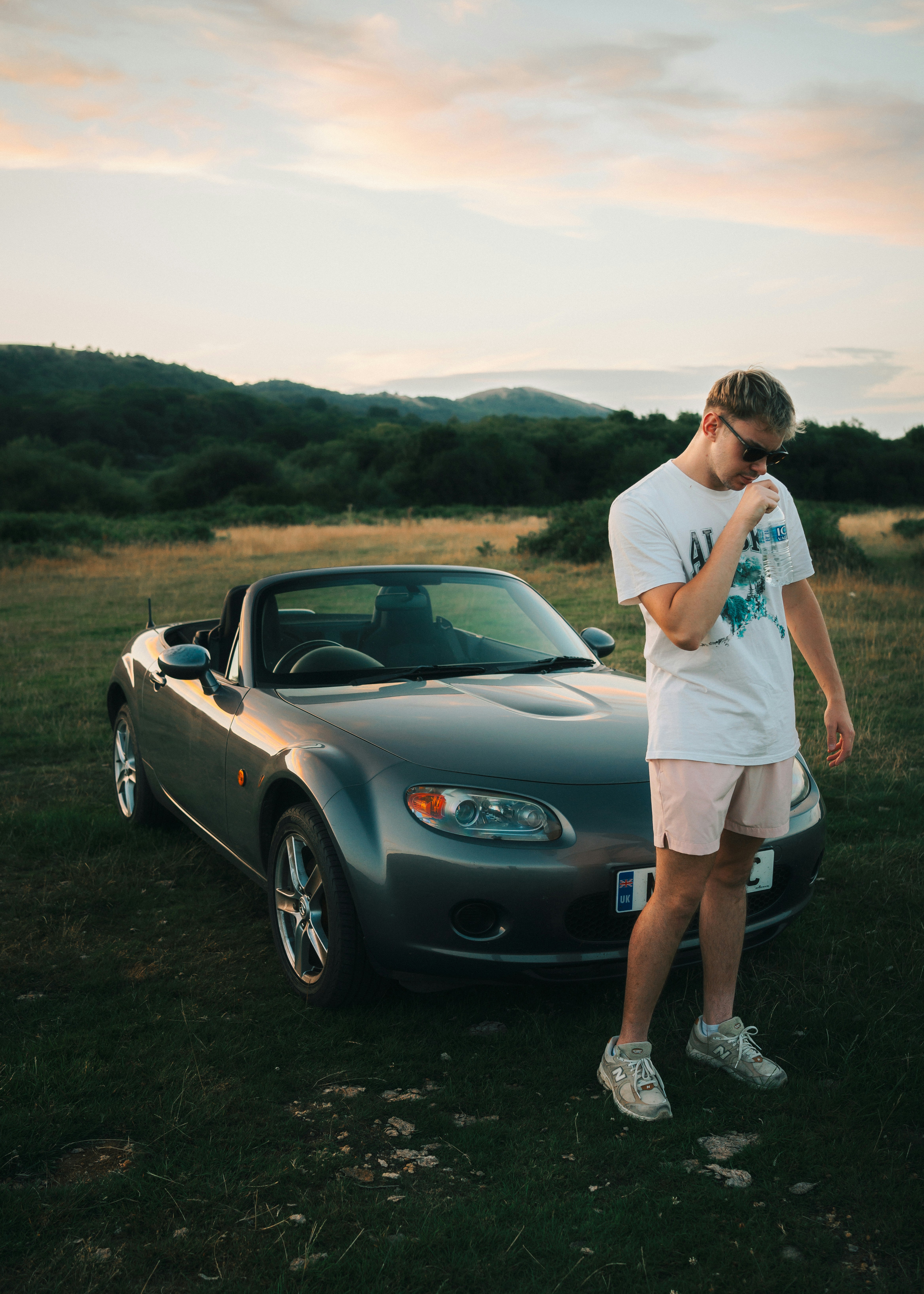 A man standing next to a sports car photo – Free Car Image on Unsplash