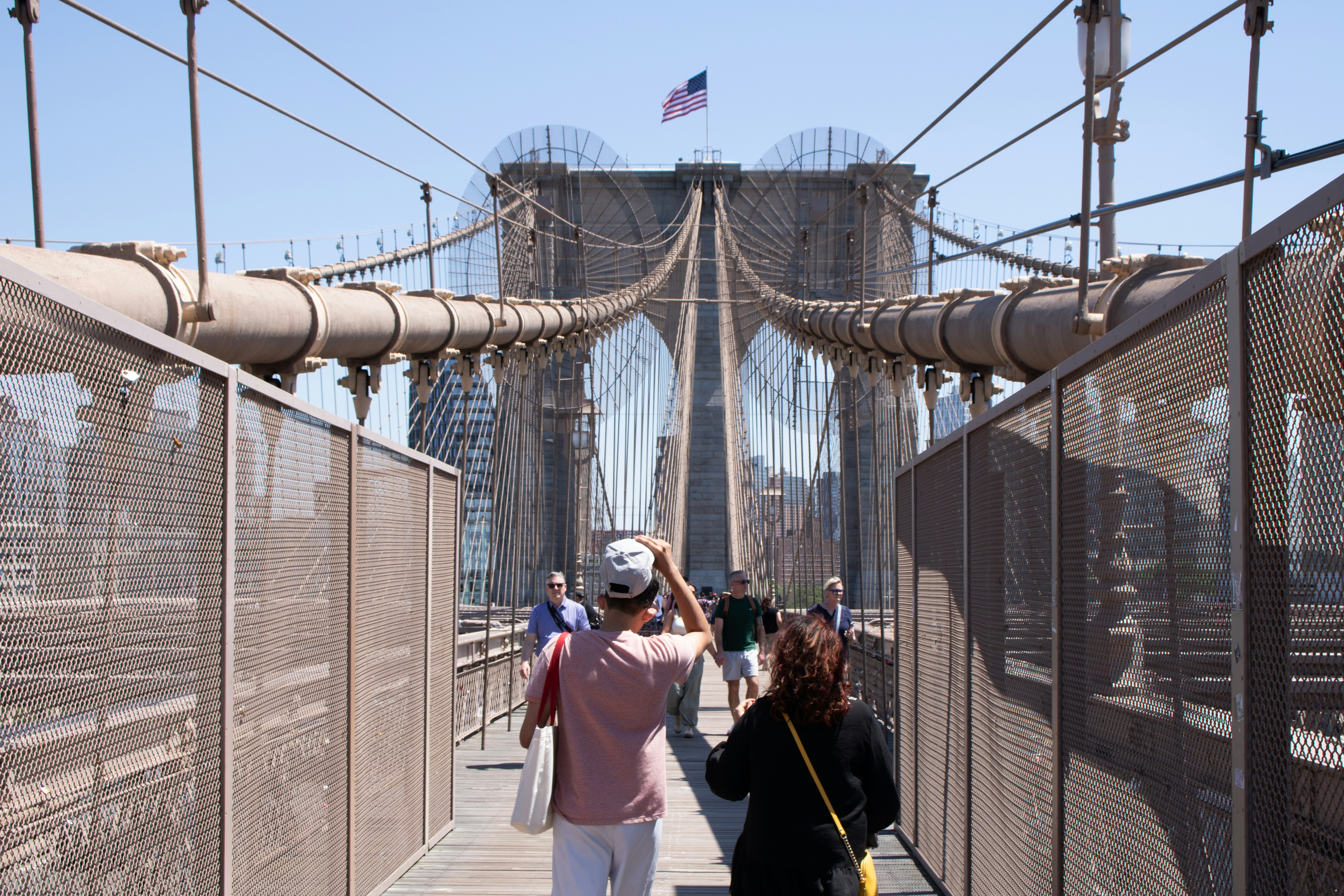 A group of people walking across a bridge photo – Free Brooklyn bridge ...