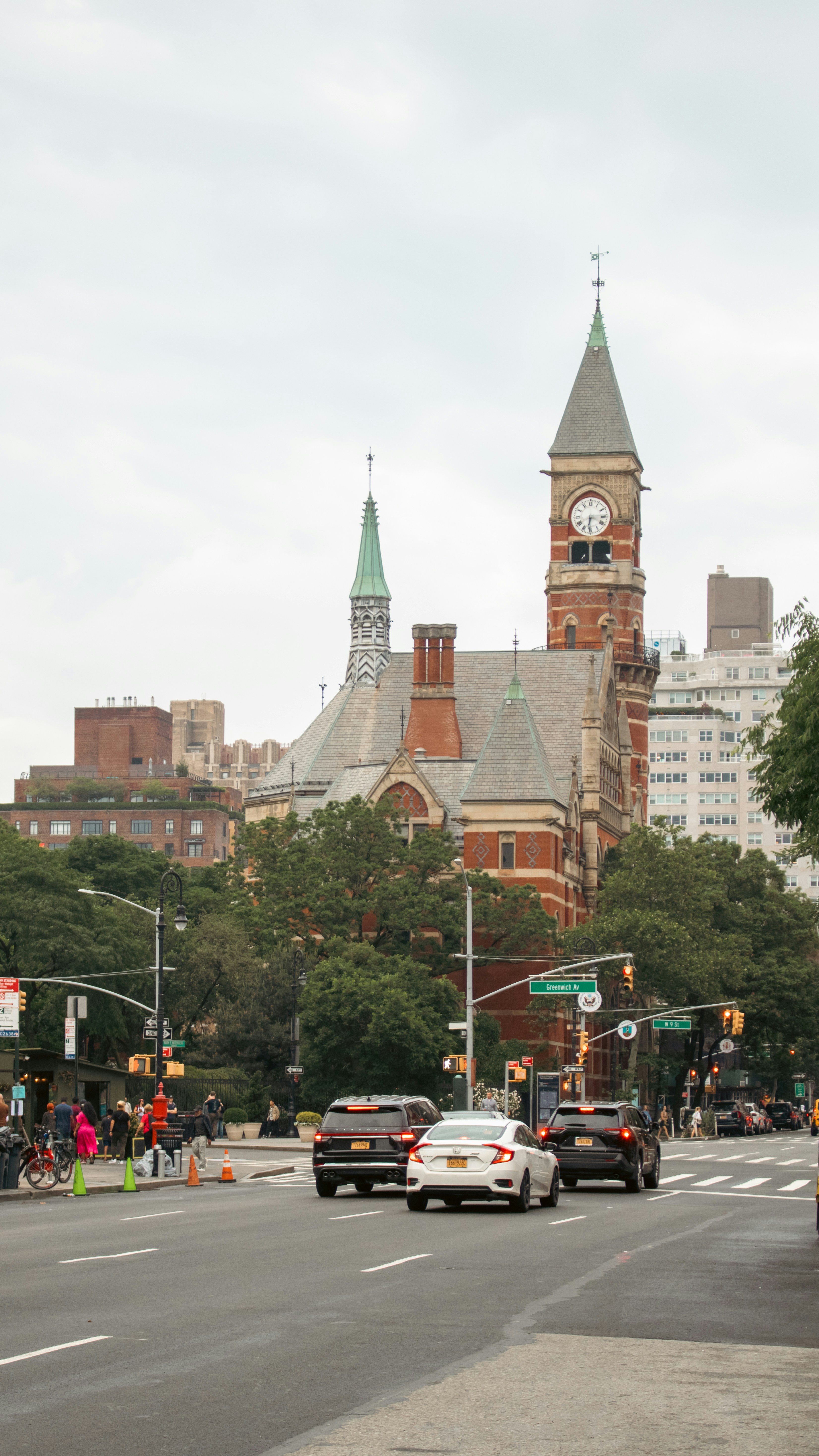 Clock Tower Crossroads: Red-Brick Landmark Over a Lively City Intersection