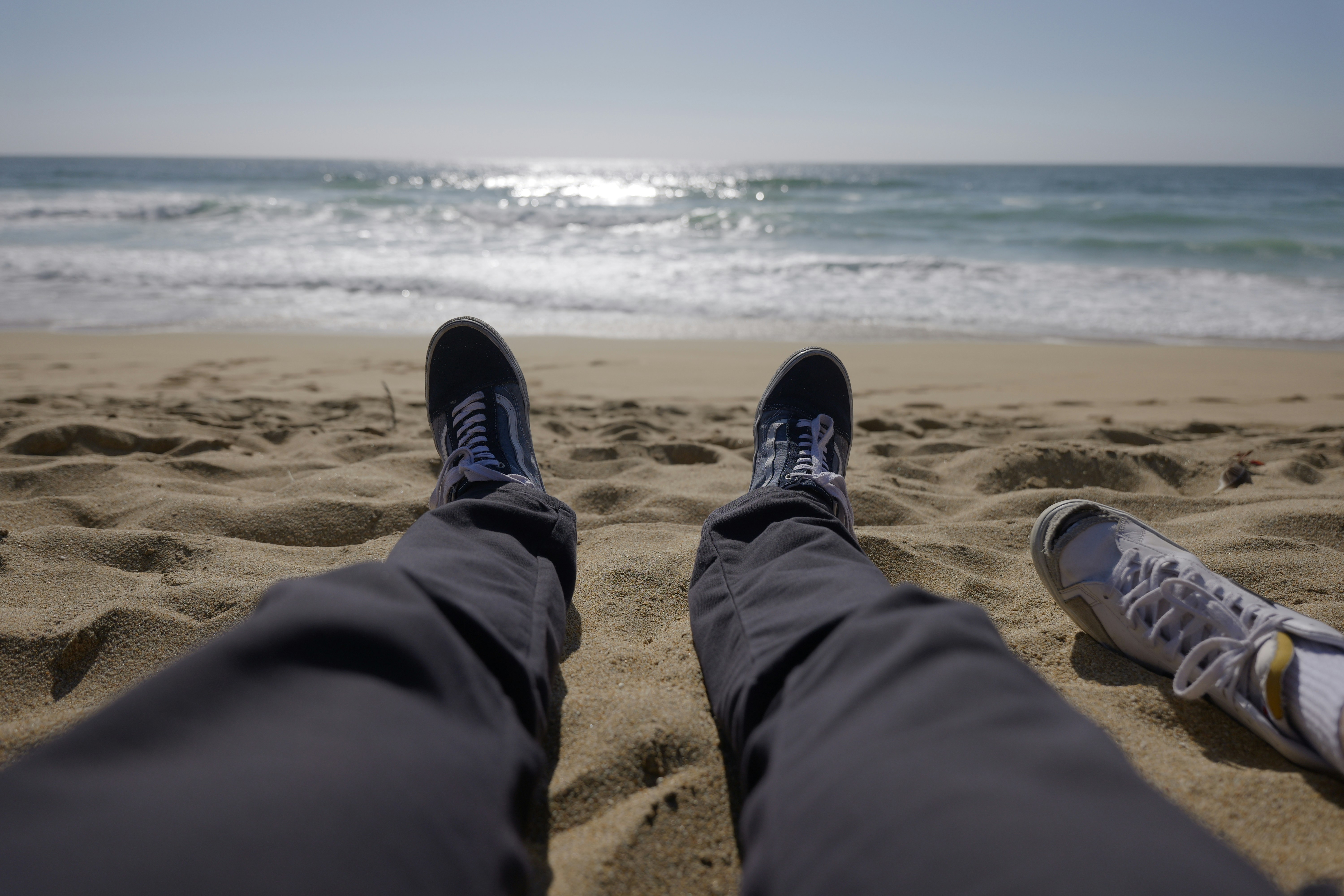 A pair of feet in the sand of a beach photo – Free Beach Image on Unsplash