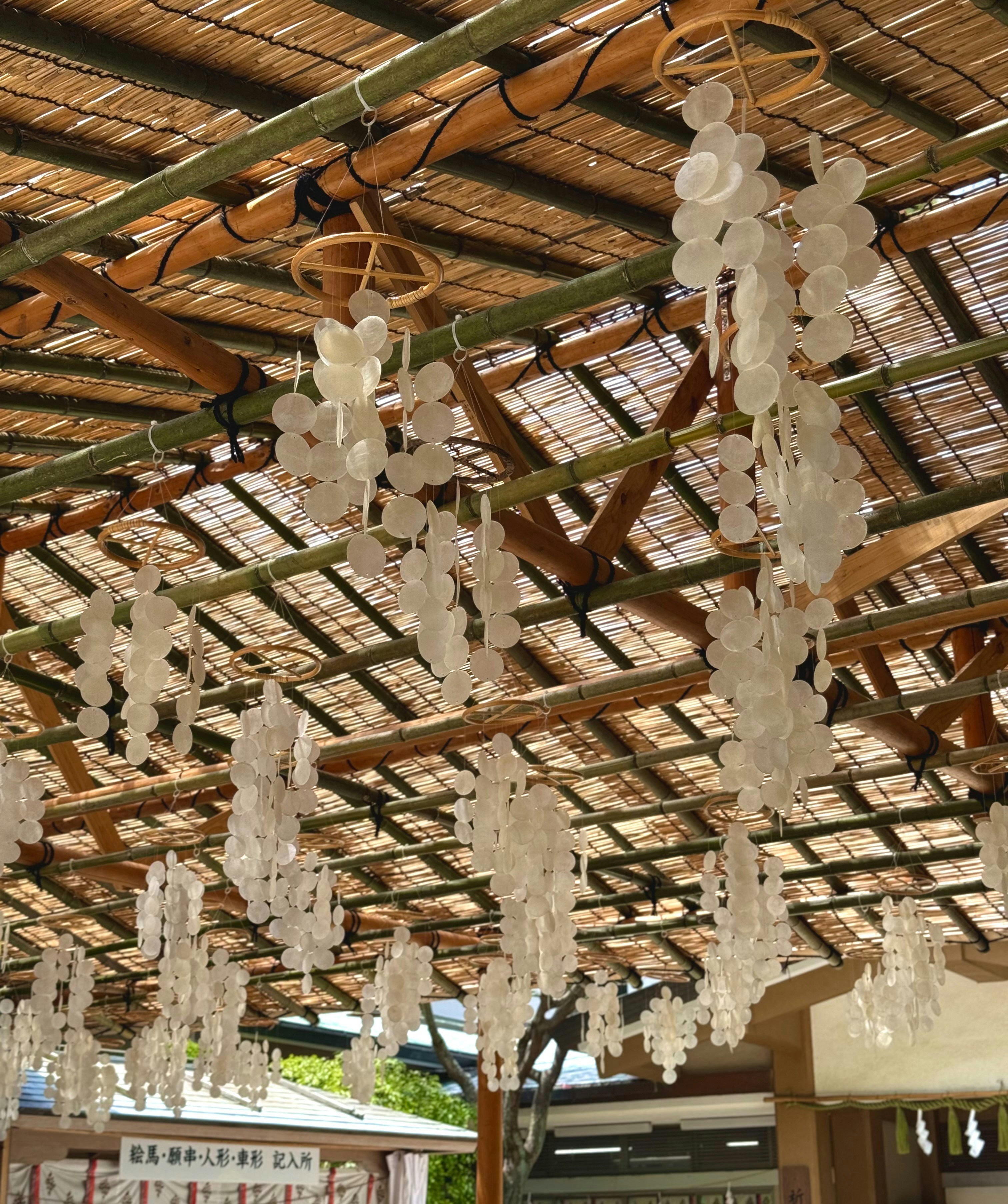 Floating White Orbs Under a Bamboo Market Roof