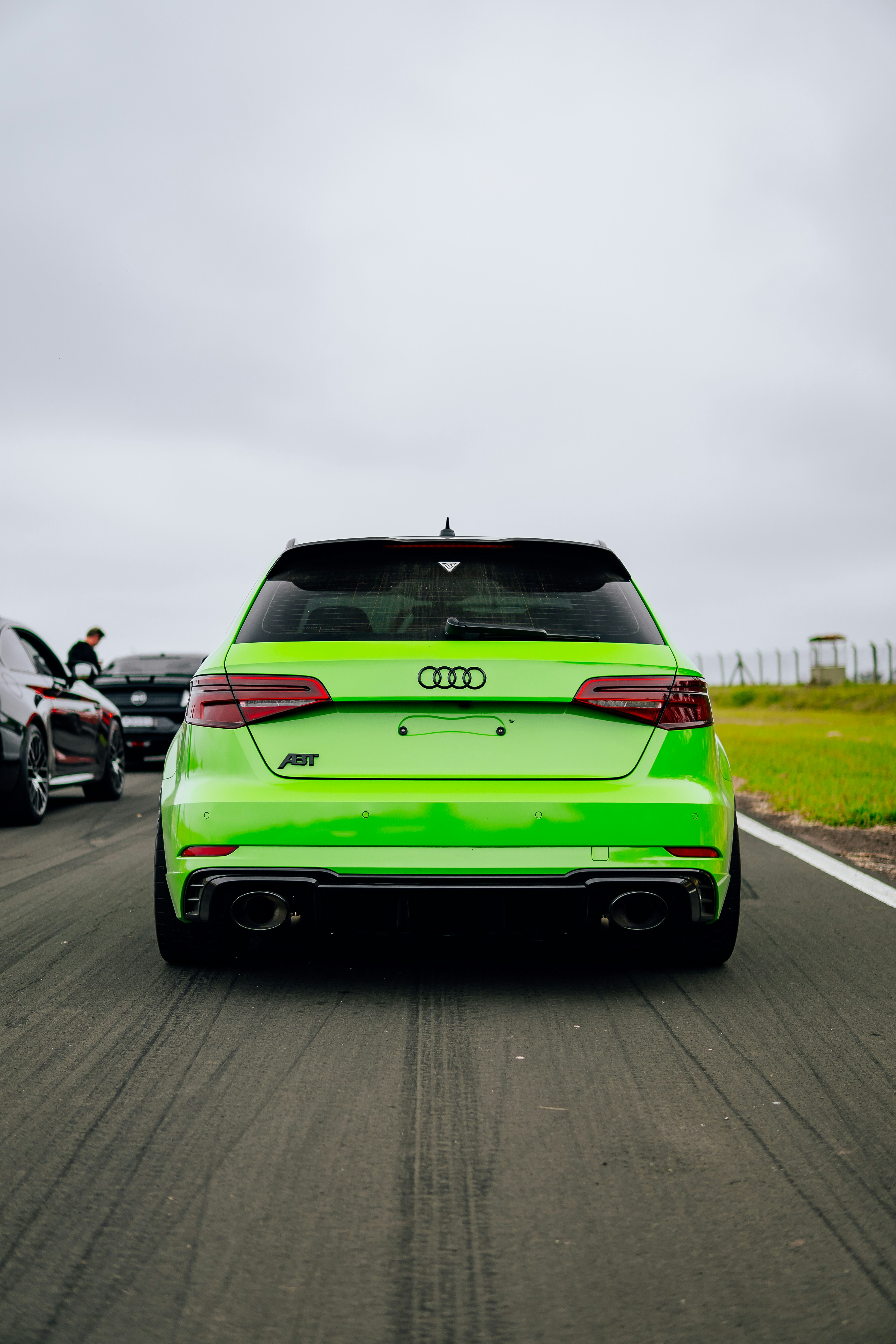 A green car driving down a road next to other cars photo – Free Pic ...