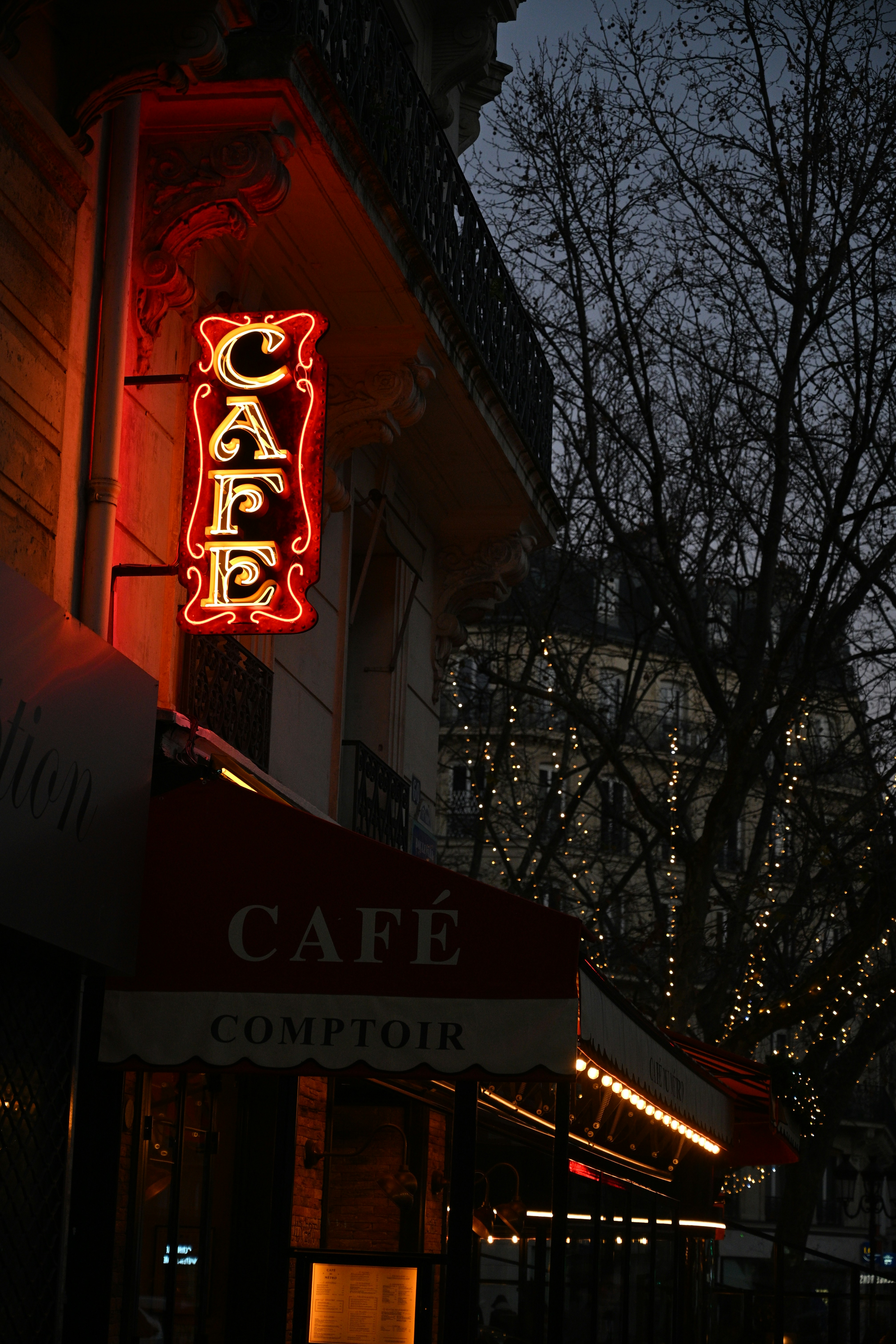 Neon Café at Dusk: Red Glow on a Lantern-Lit Street
