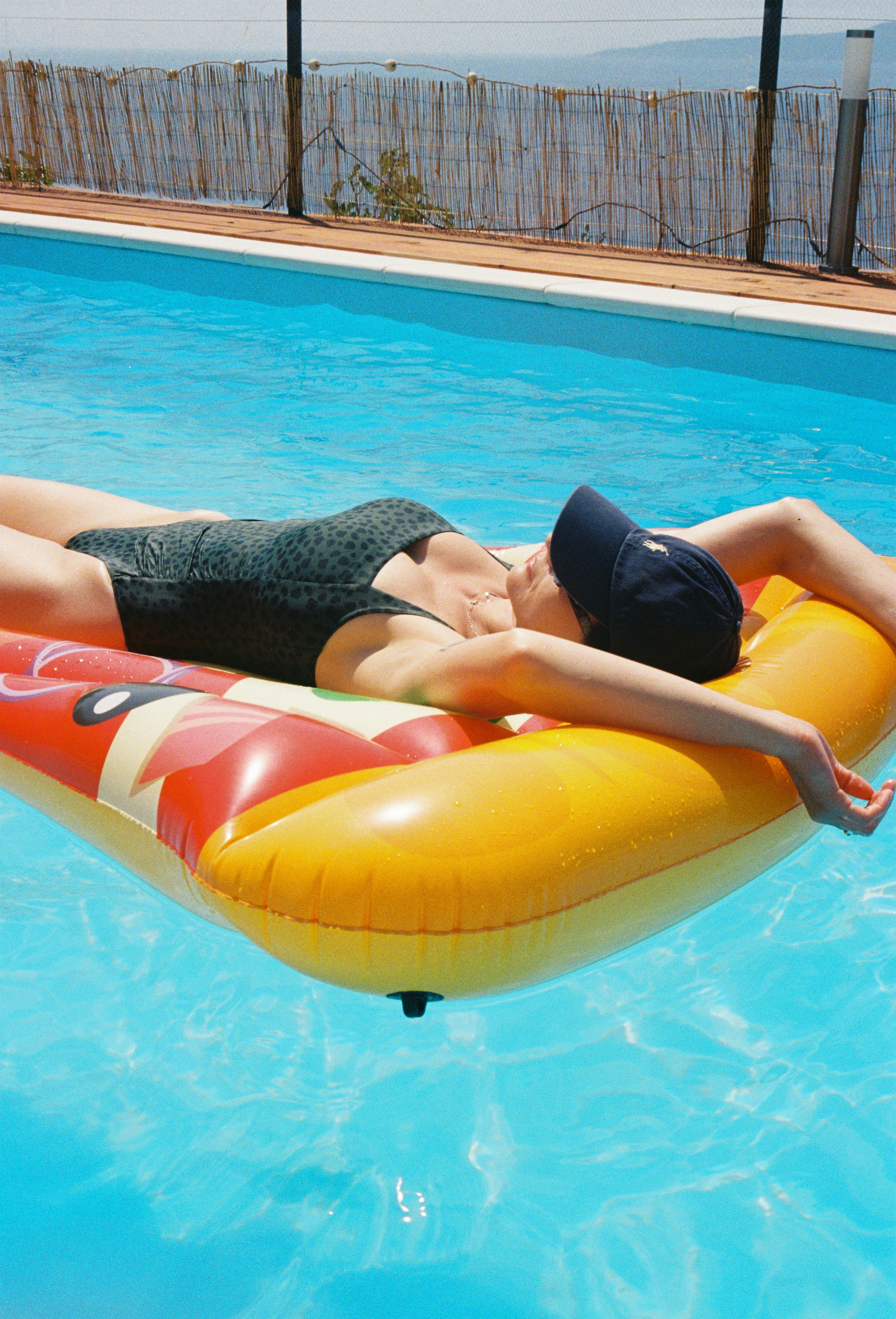 A woman laying on an inflatable raft in a swimming pool photo – Free ...