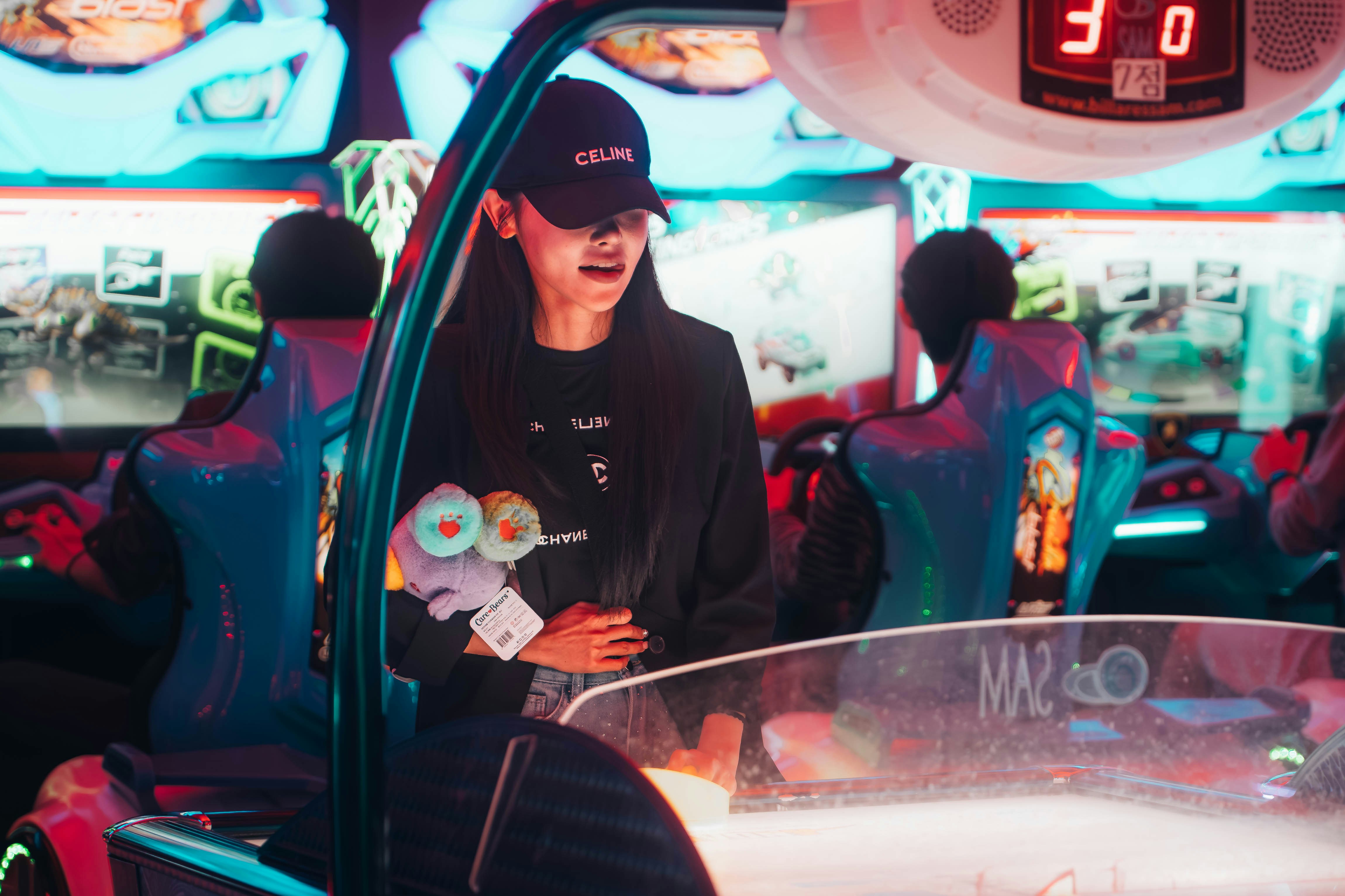 Neon Carousel Moment: A Youthful Fan in the Arcade Spotlight