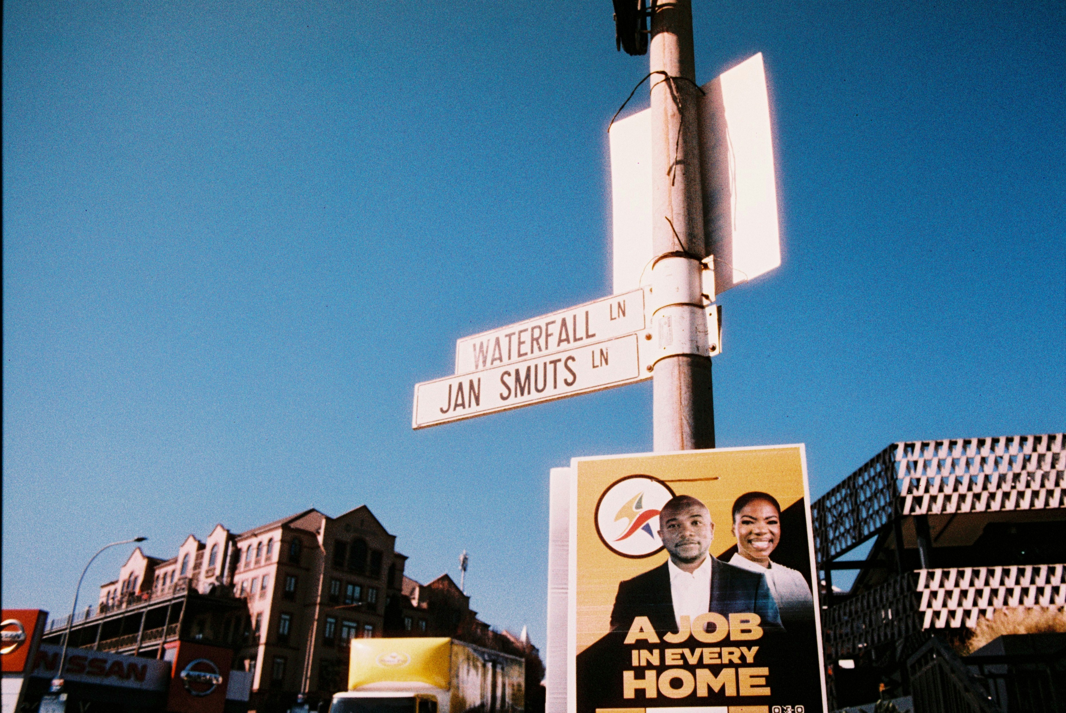 A street sign with a political poster on it photo – Free Analog ...