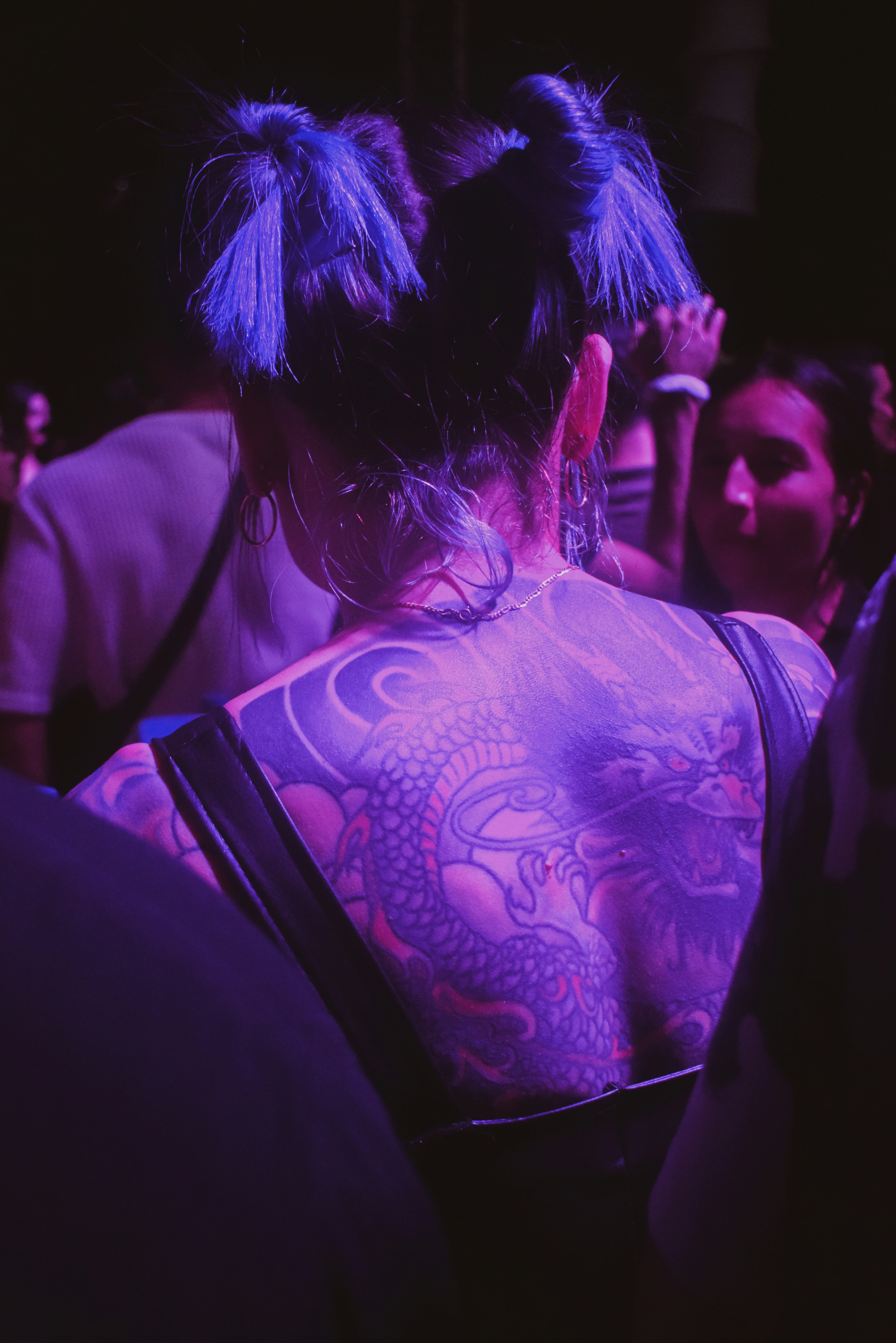 Dragon Tattoo in Neon Violet: A Nightclub Portrait