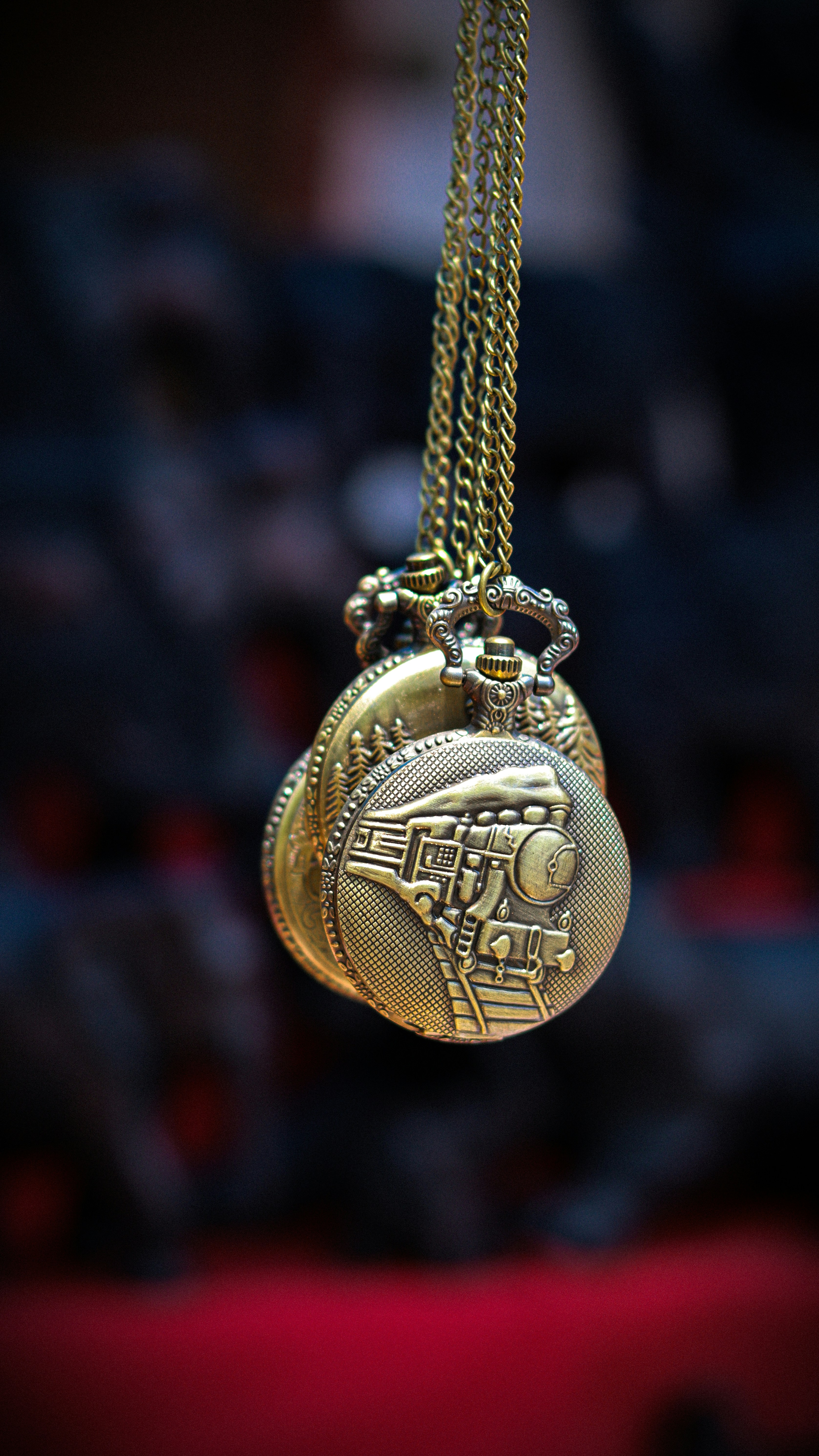 Floating Gold: Close-Up of Ornate Pocket Watches on a Delicate Chain