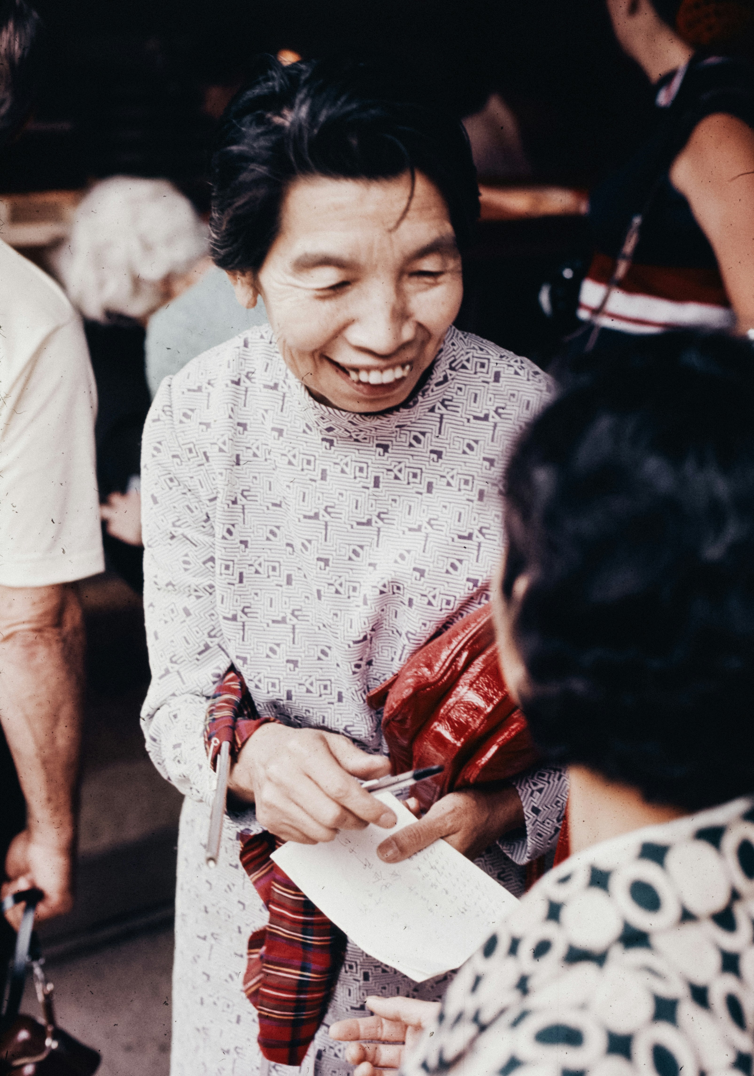 A group of people standing around each other photo – Free Person Image ...