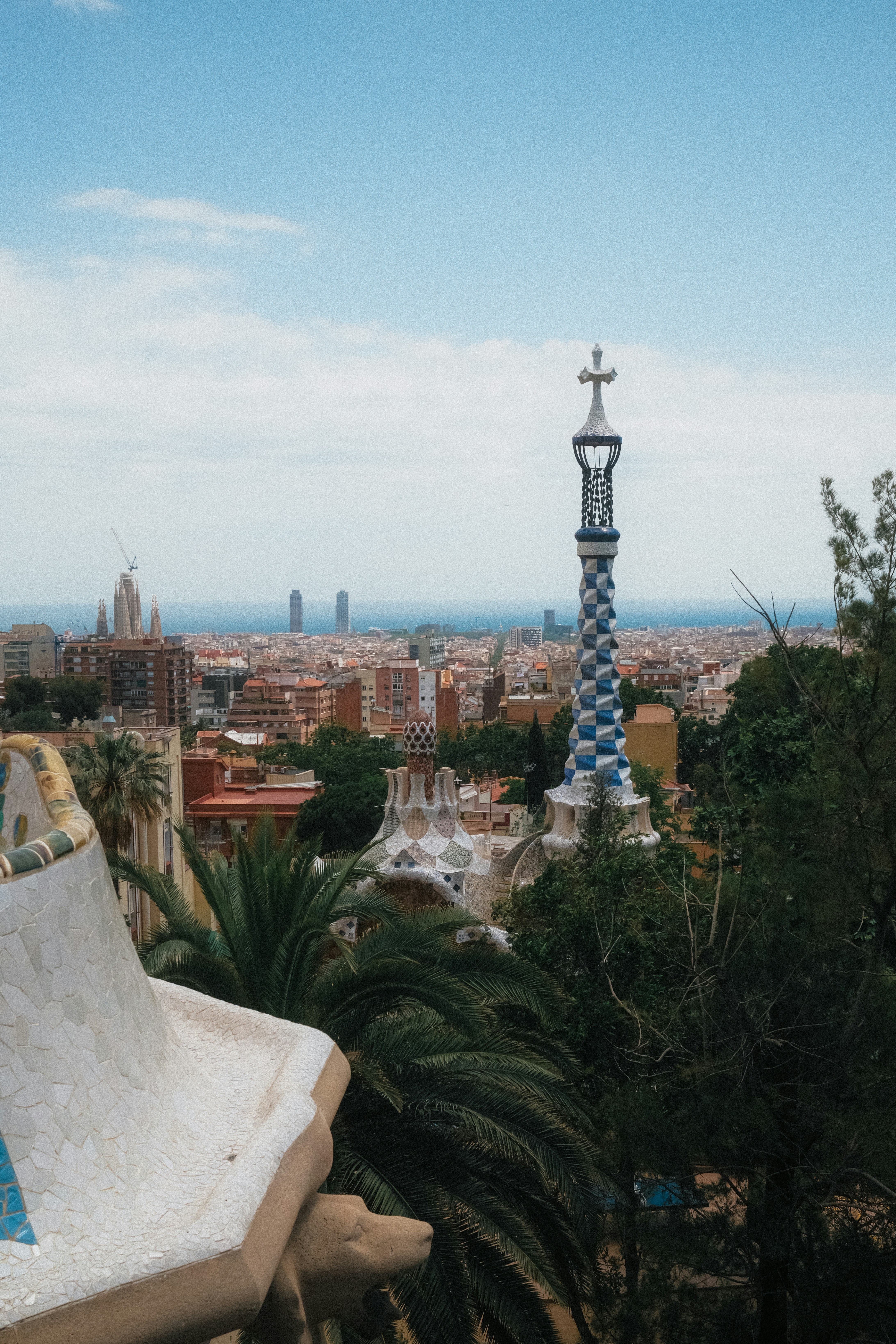 Spiral Spire Over Barcelona: Mosaic-Tile Vista from Gaudí’s Park Güell