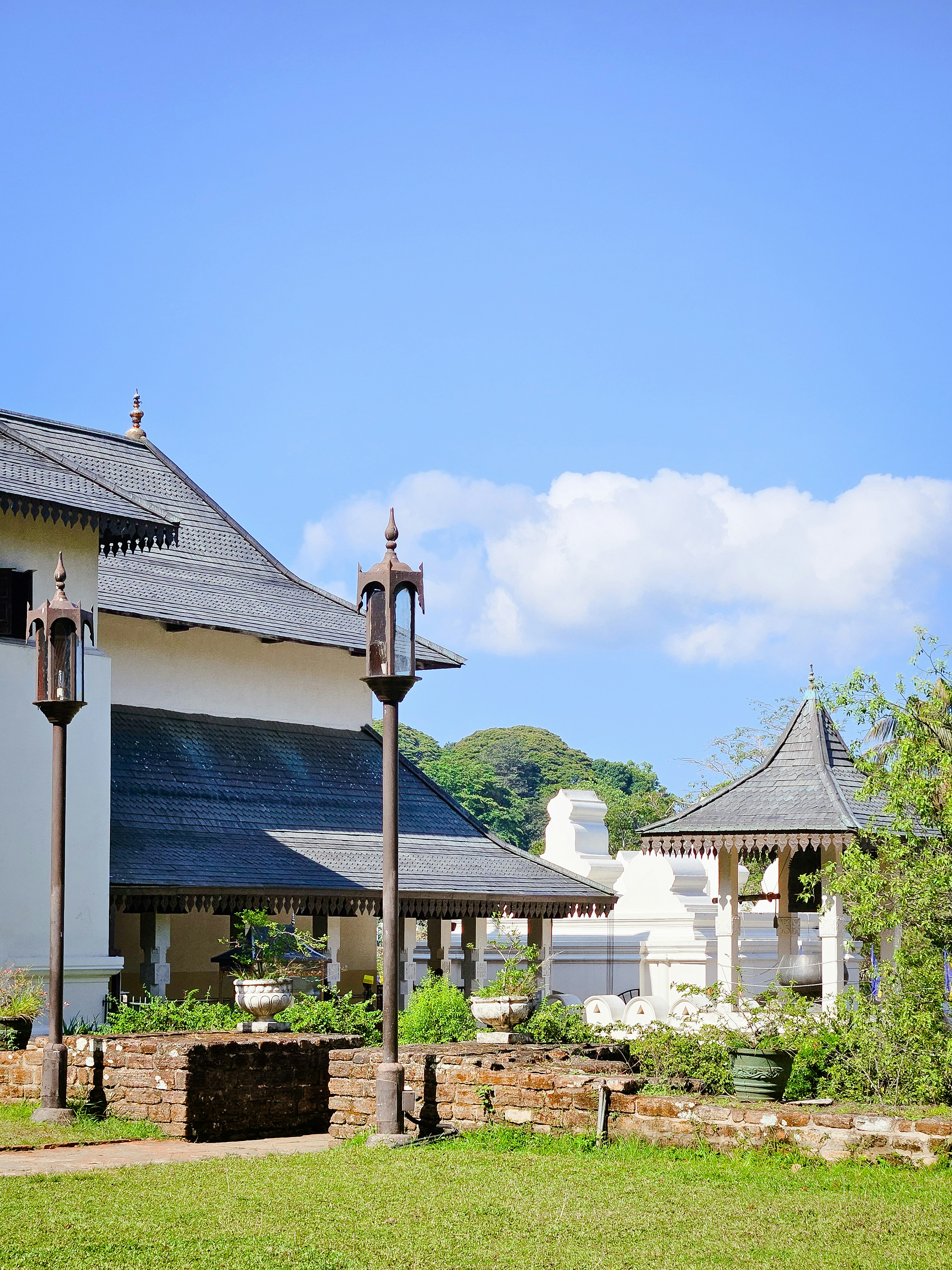 A large white building sitting on top of a lush green field