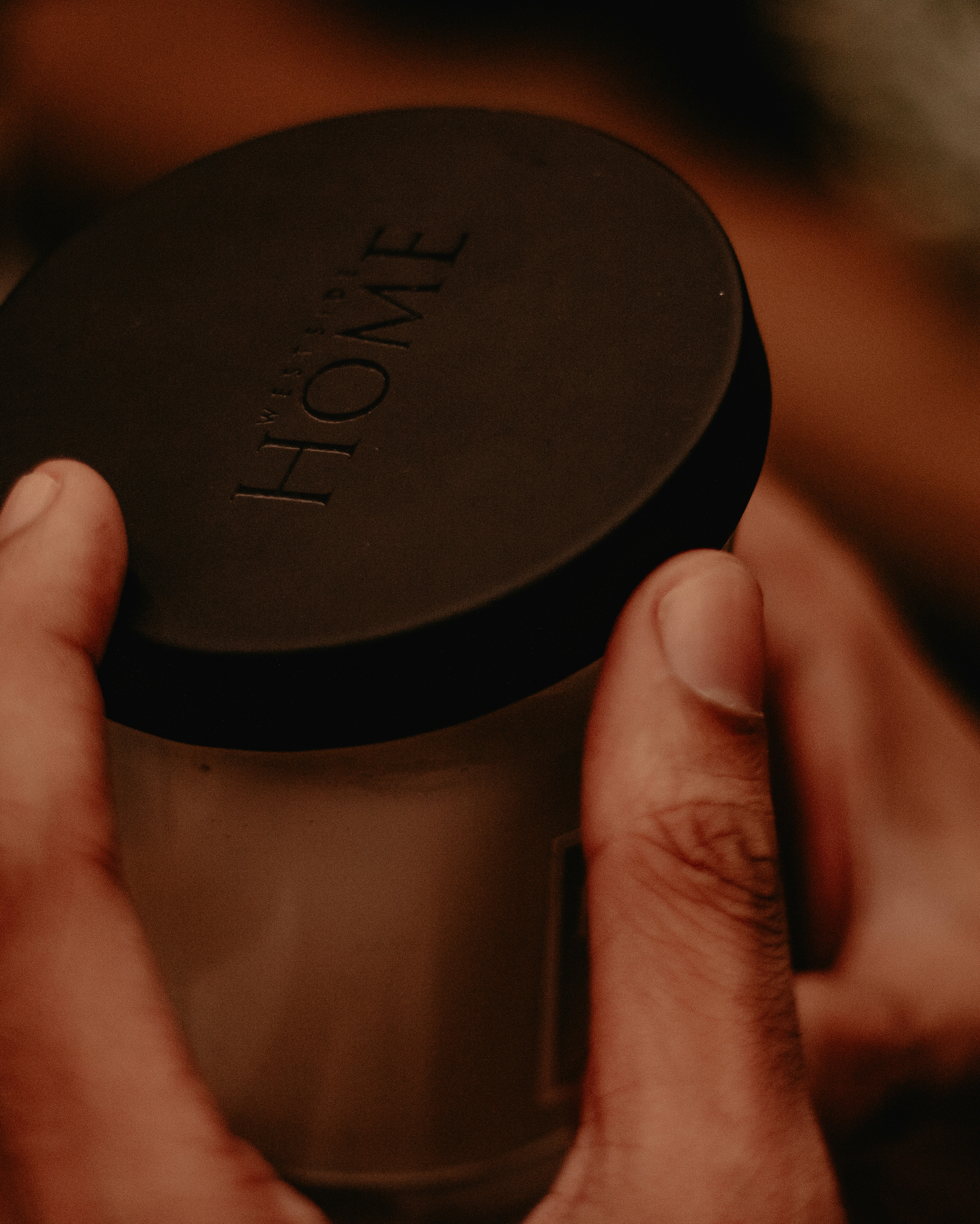 Grasped Home: Warm Close-Up of a Lidded Jar
