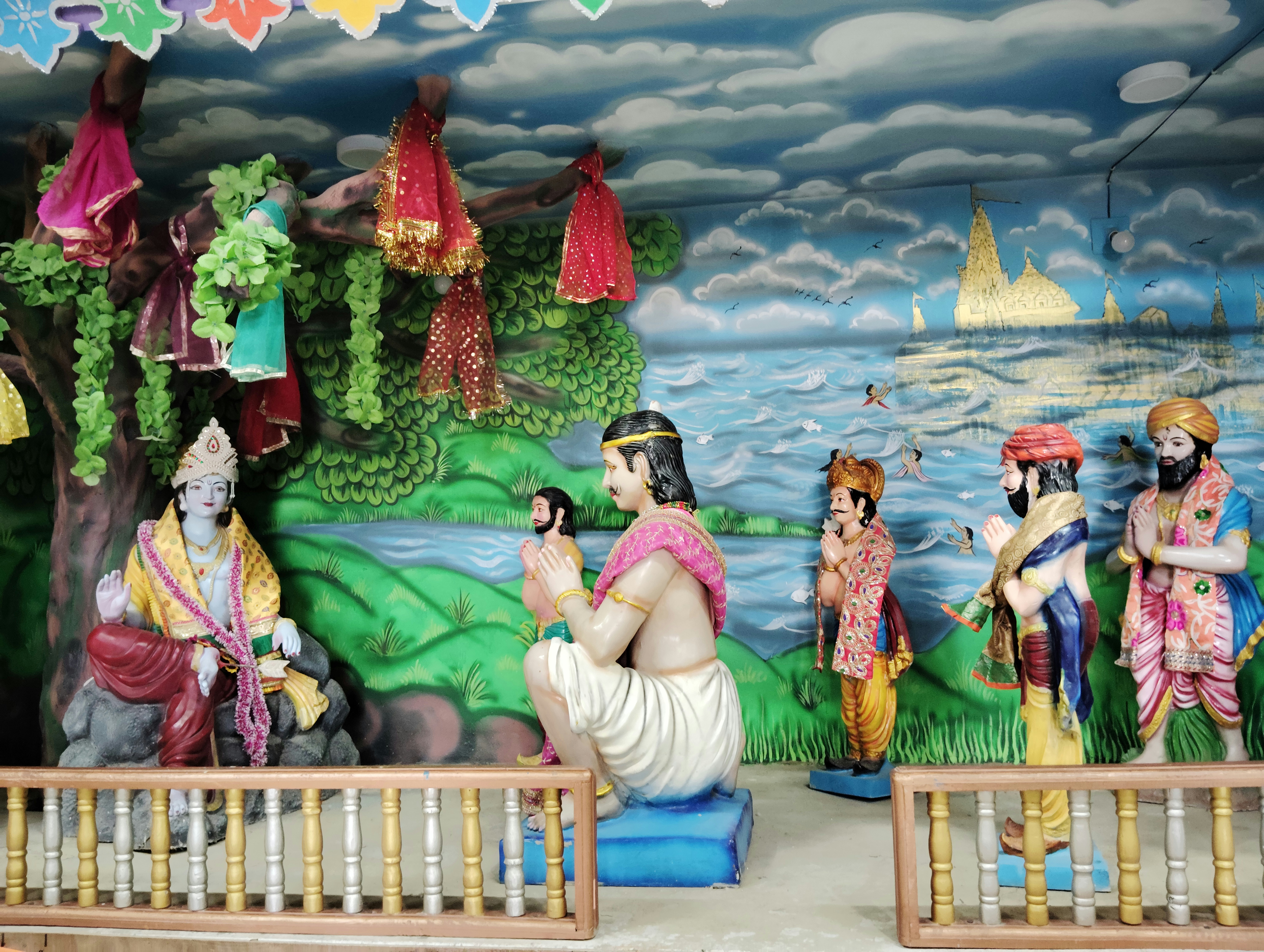 A group of statues sitting on top of a stage photo – Free Flower Image ...