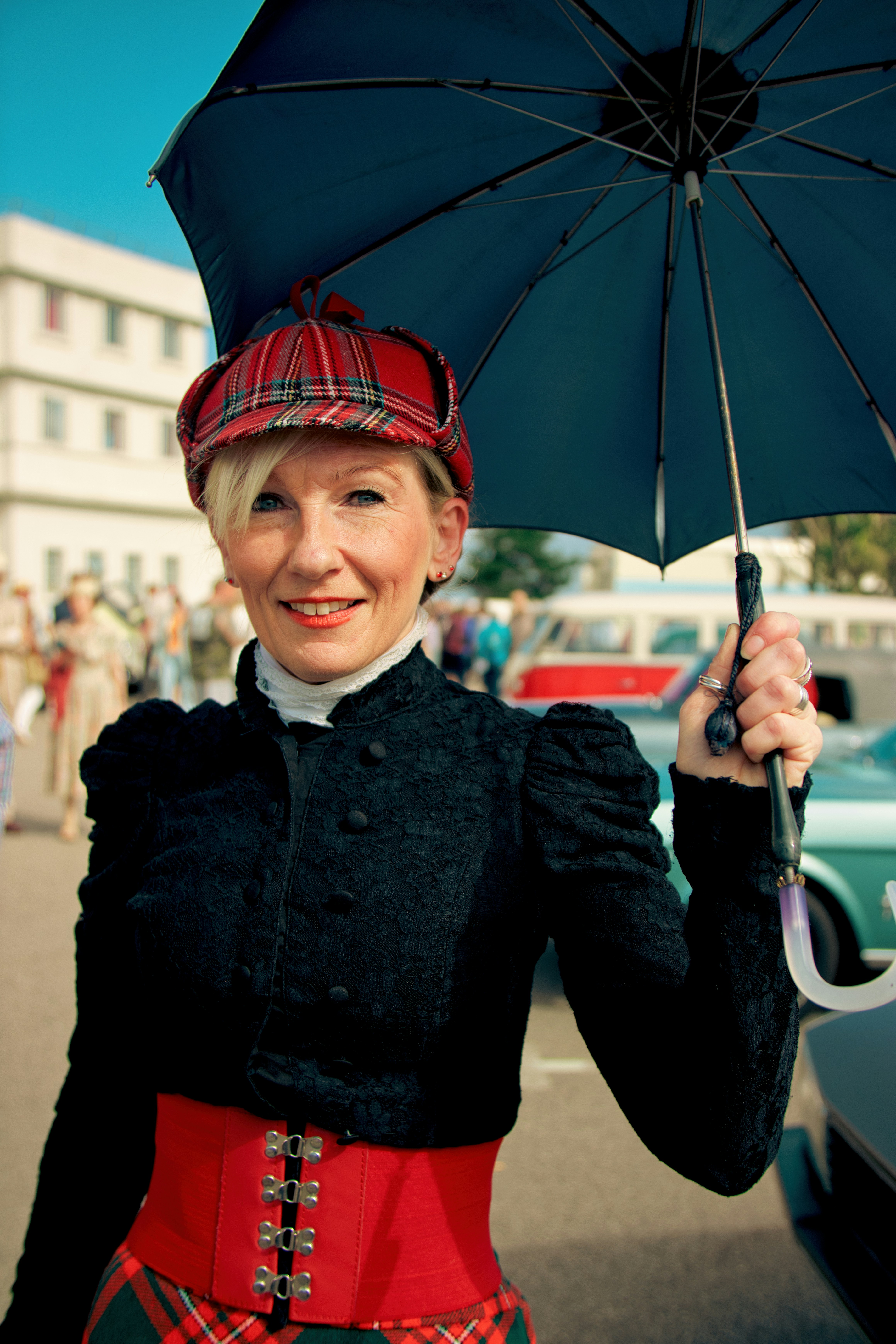 Red Corset, Blue Umbrella: Vintage Portrait on a Bustling Street