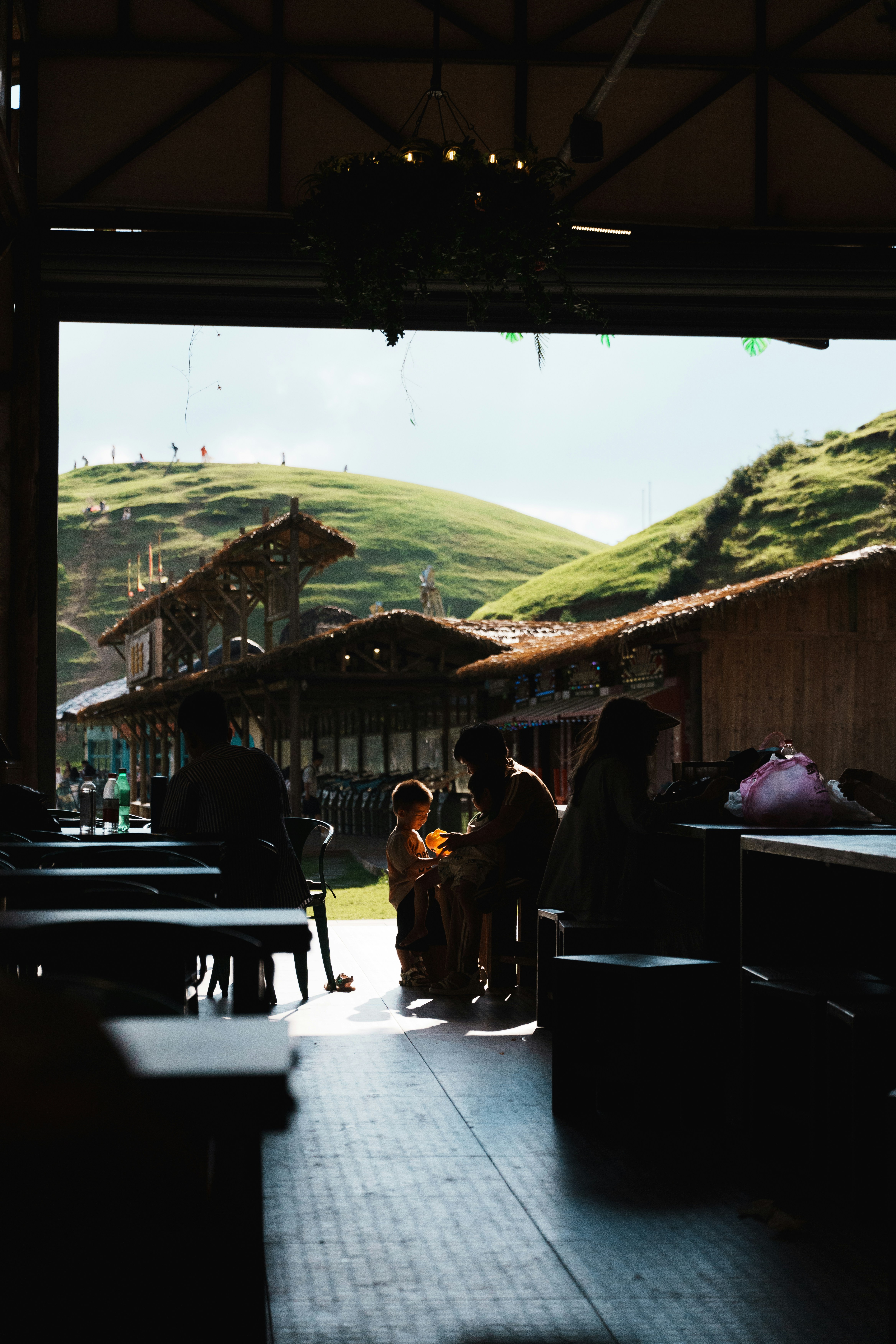 Threshold of Light: Silhouettes at a Hilltop Café