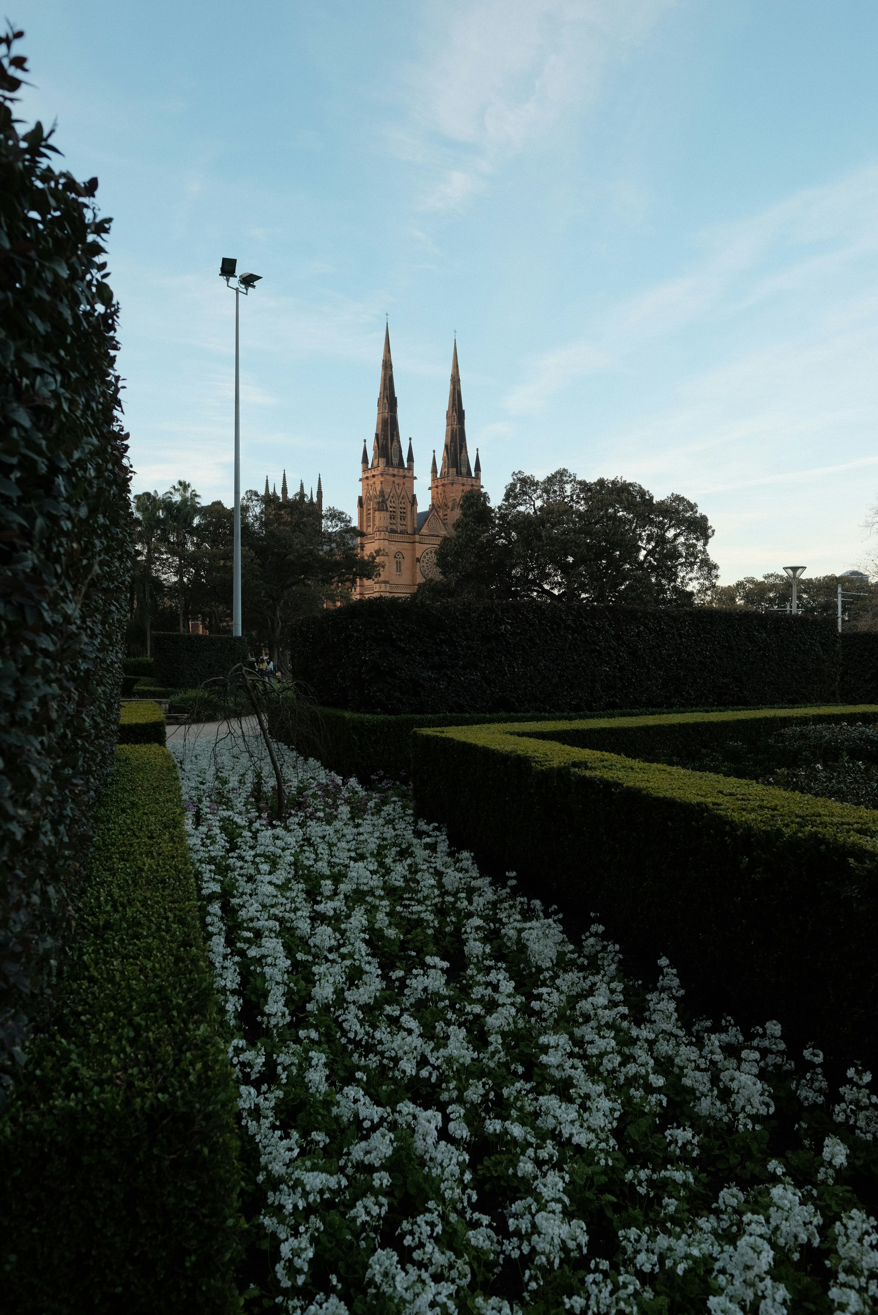 Twin Spires Over a Formal Garden at Dusk