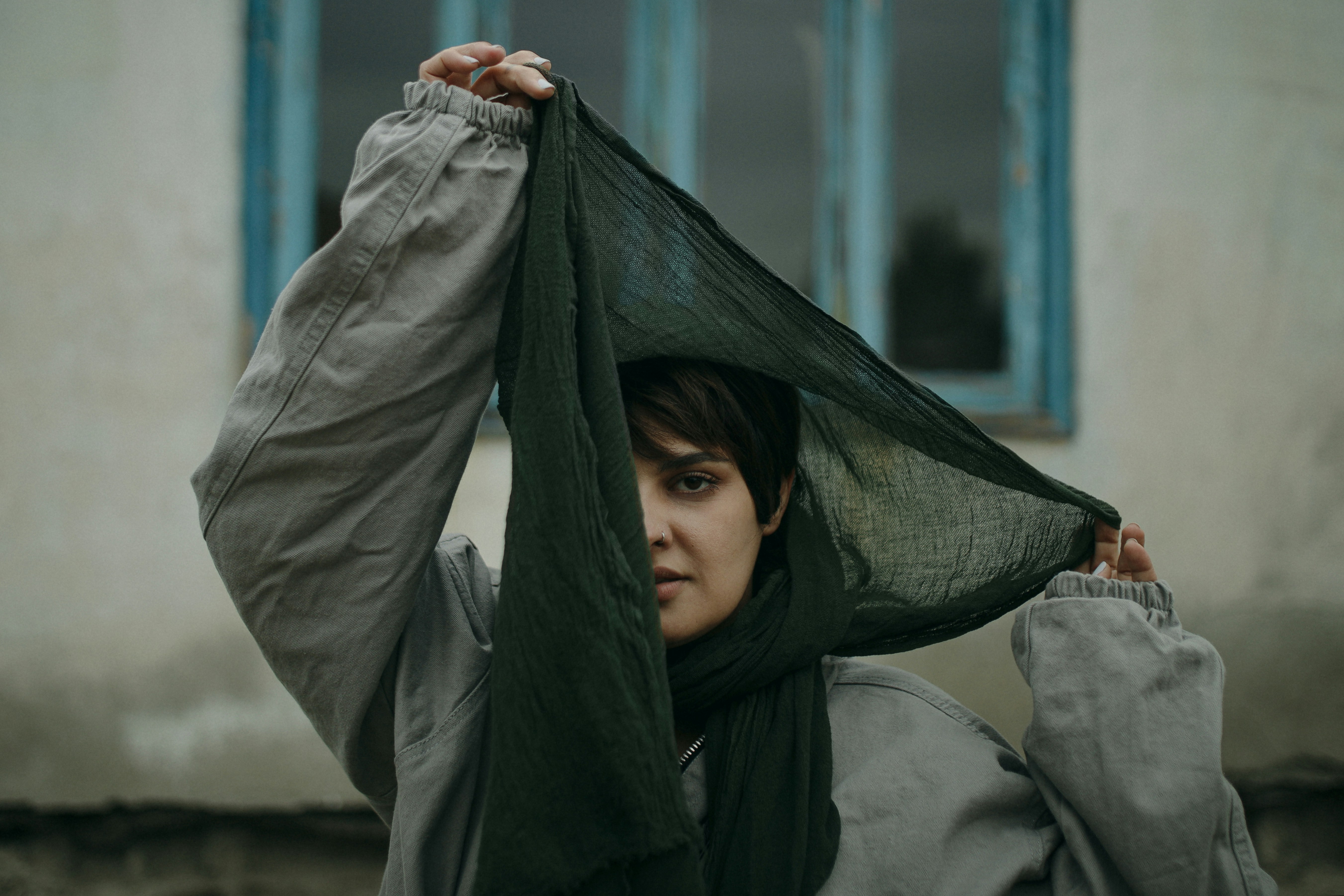 Glimpse Through the Veil: Portrait in Grey Light