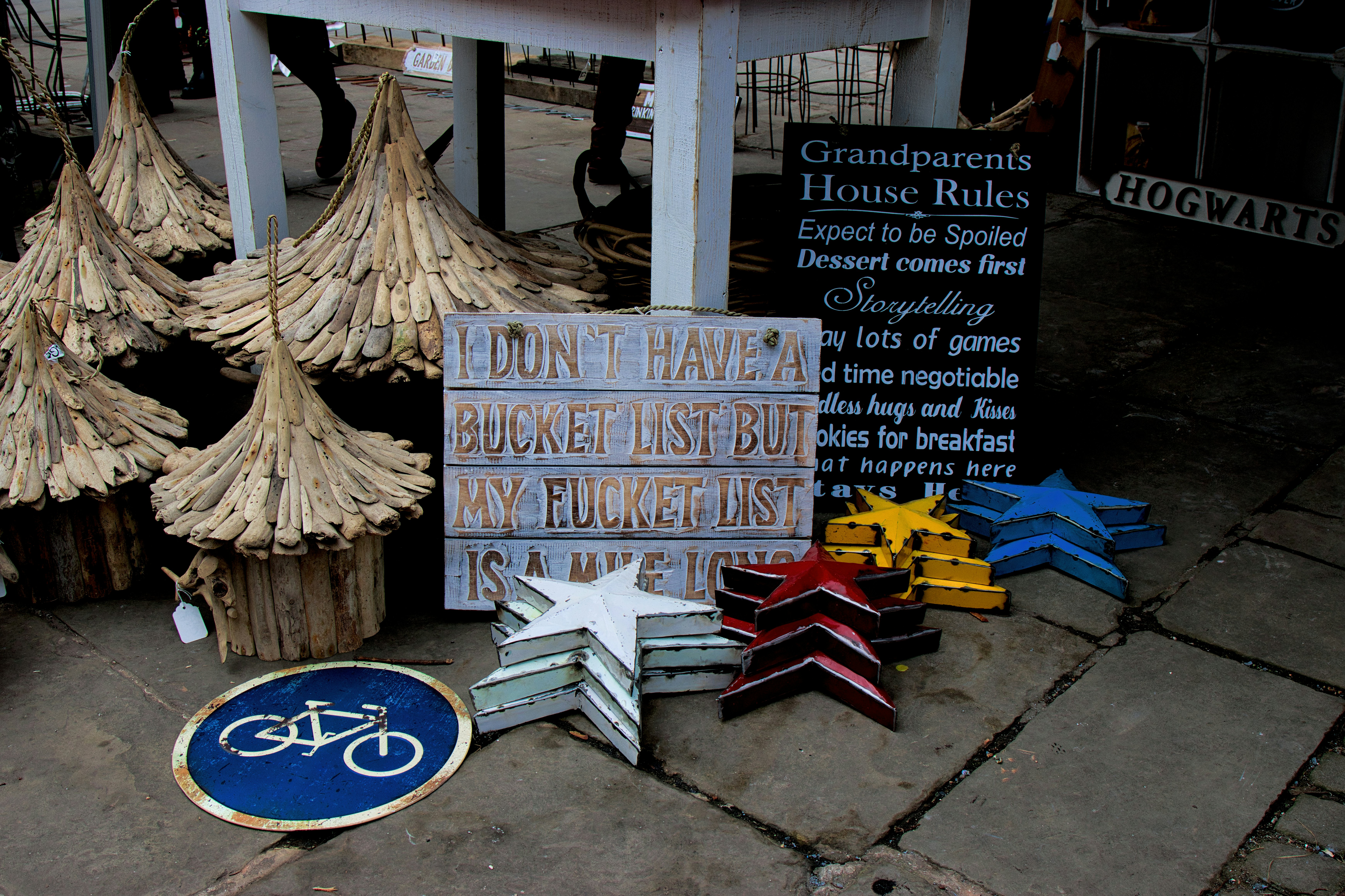 Bucket-List Signage Among Colorful Star Stacks in a Quiet Market