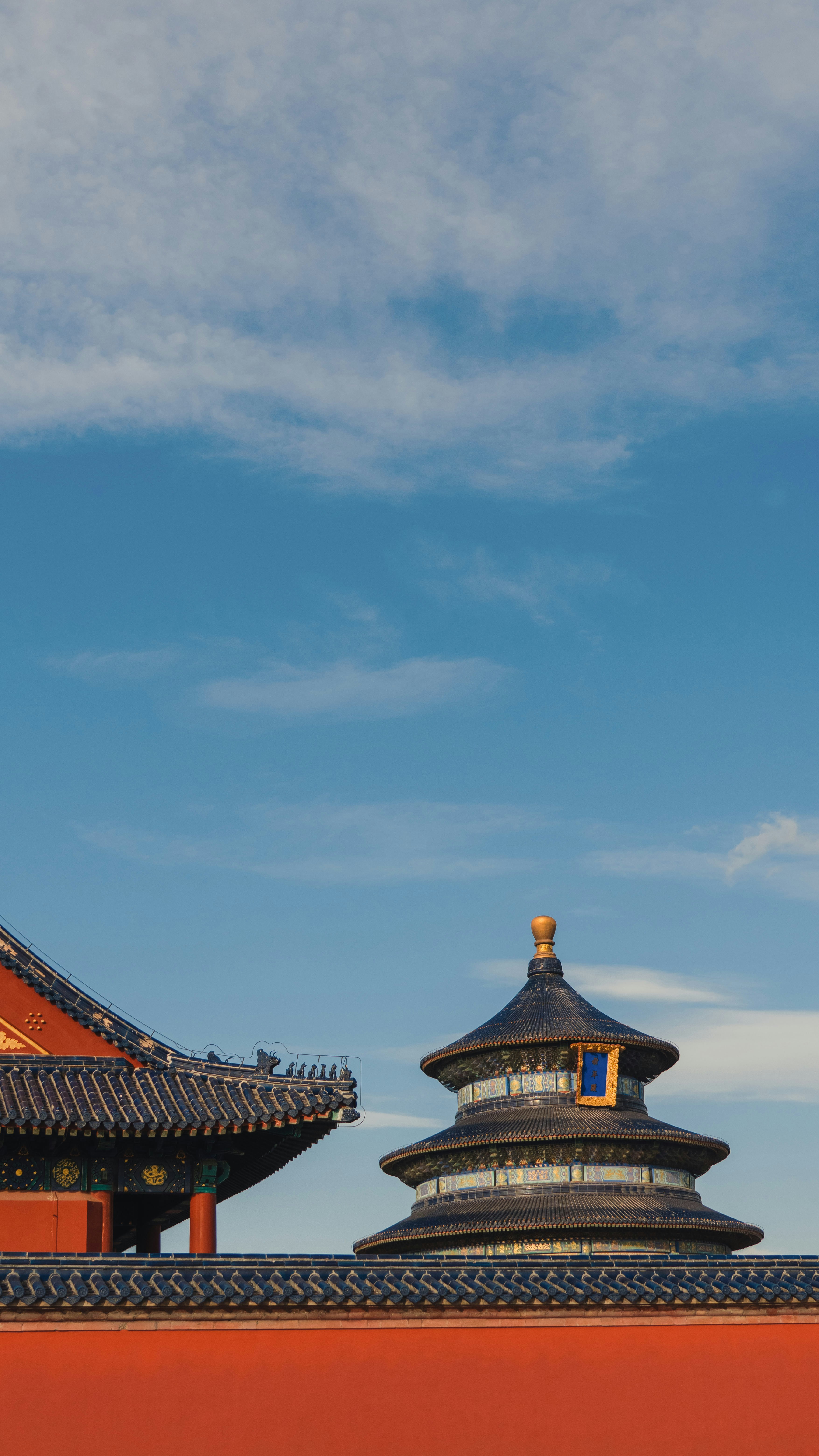A red wall with a clock tower in the background photo – Free Beijing ...