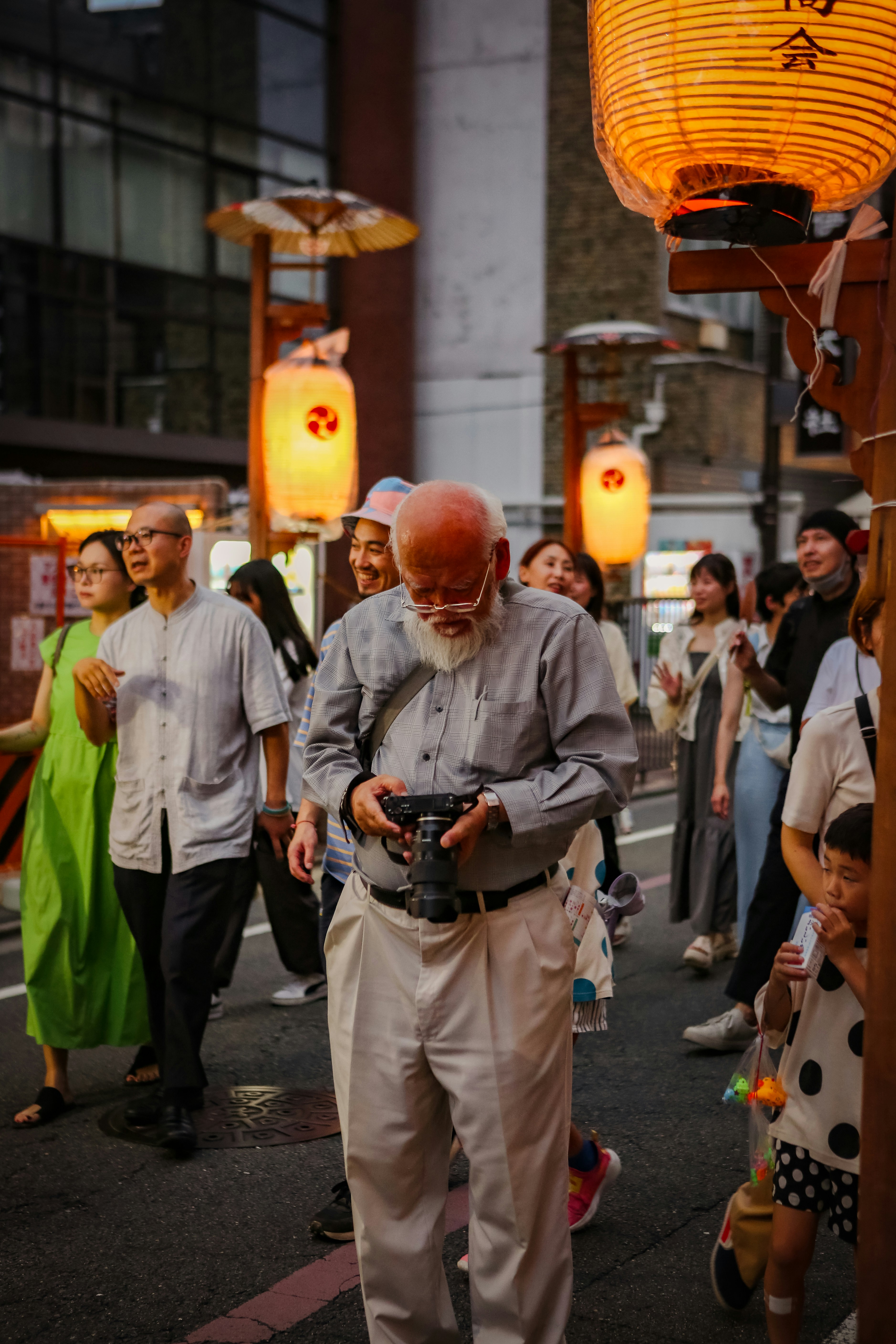 The Gentle Photographer Amid Lantern Light