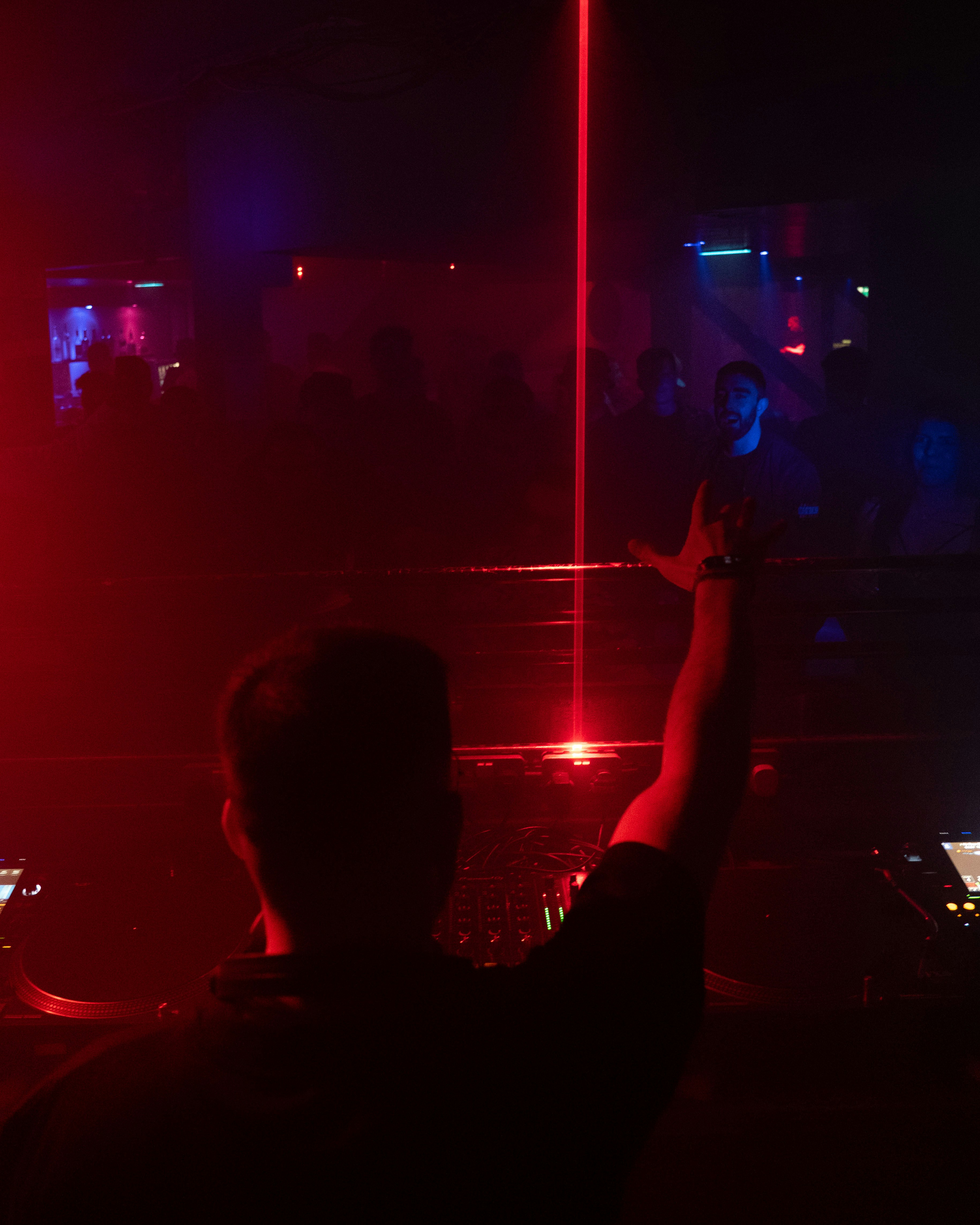 A dj mixing in front of a crowd at a concert photo – Free Urban Image ...