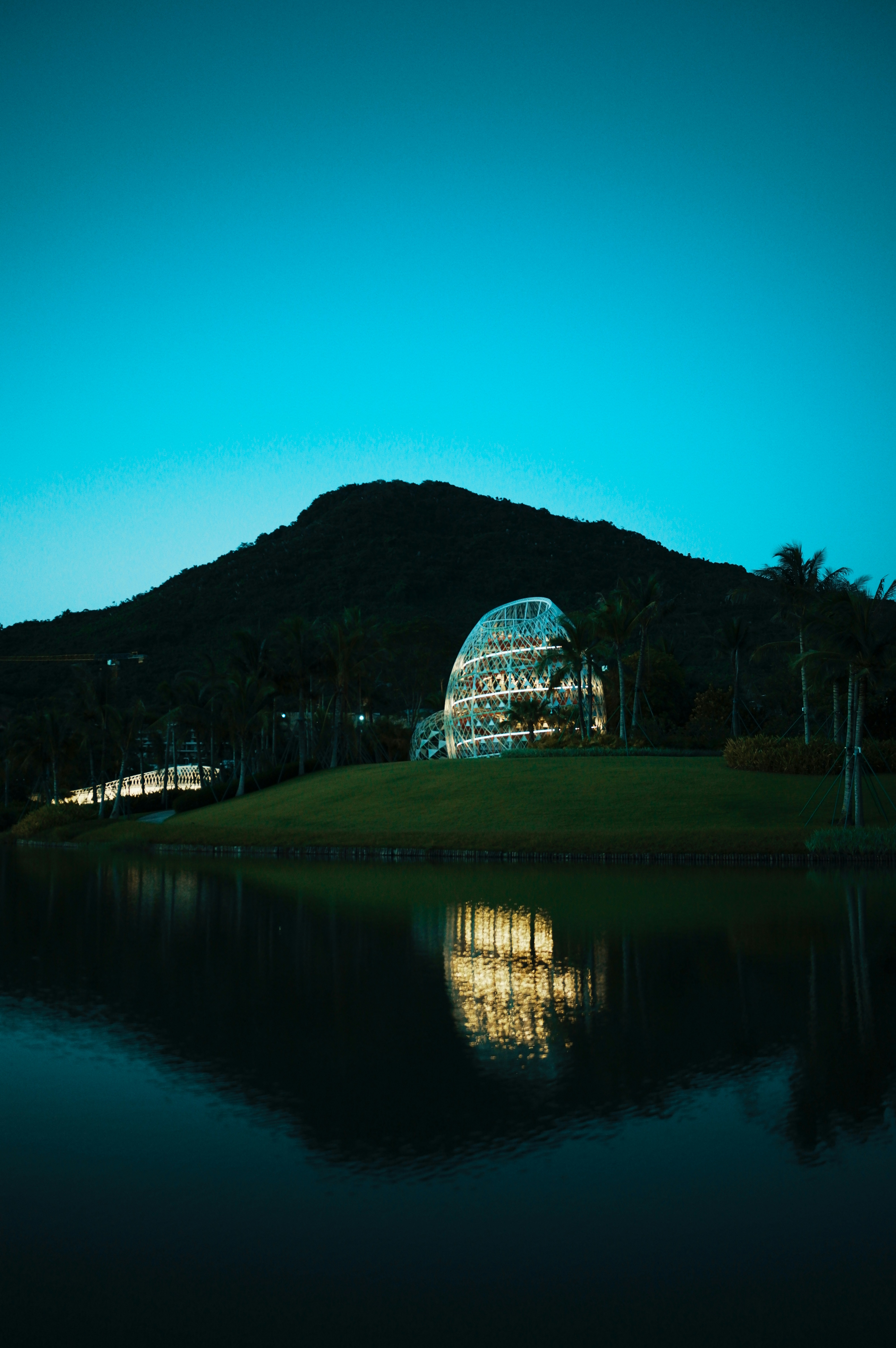 Luminous Glass Dome Framing a Quiet Lake at Emerald Hill