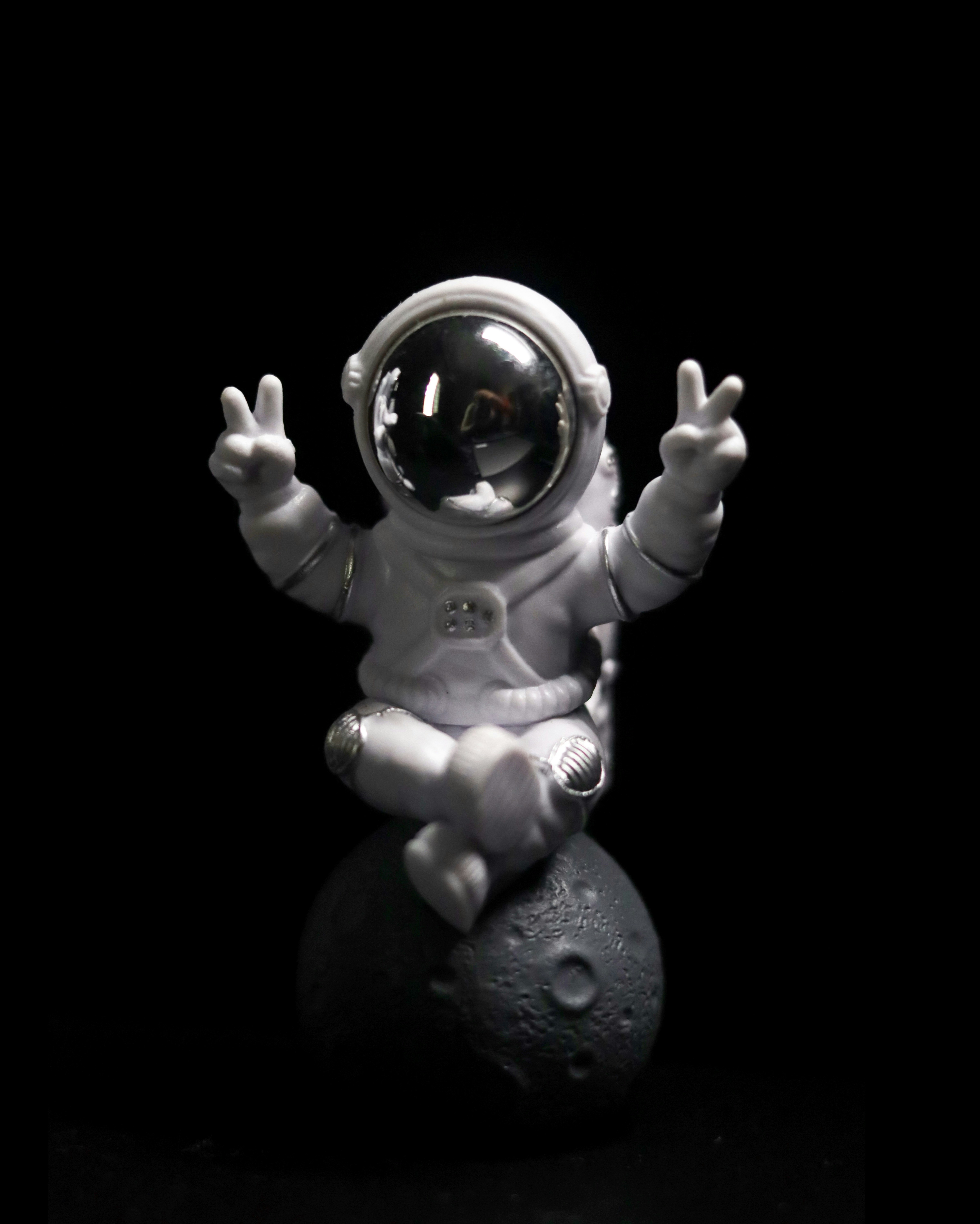 Peaceful Sentinel on a Moonlet: A Tiny Astronaut Posed in Silence