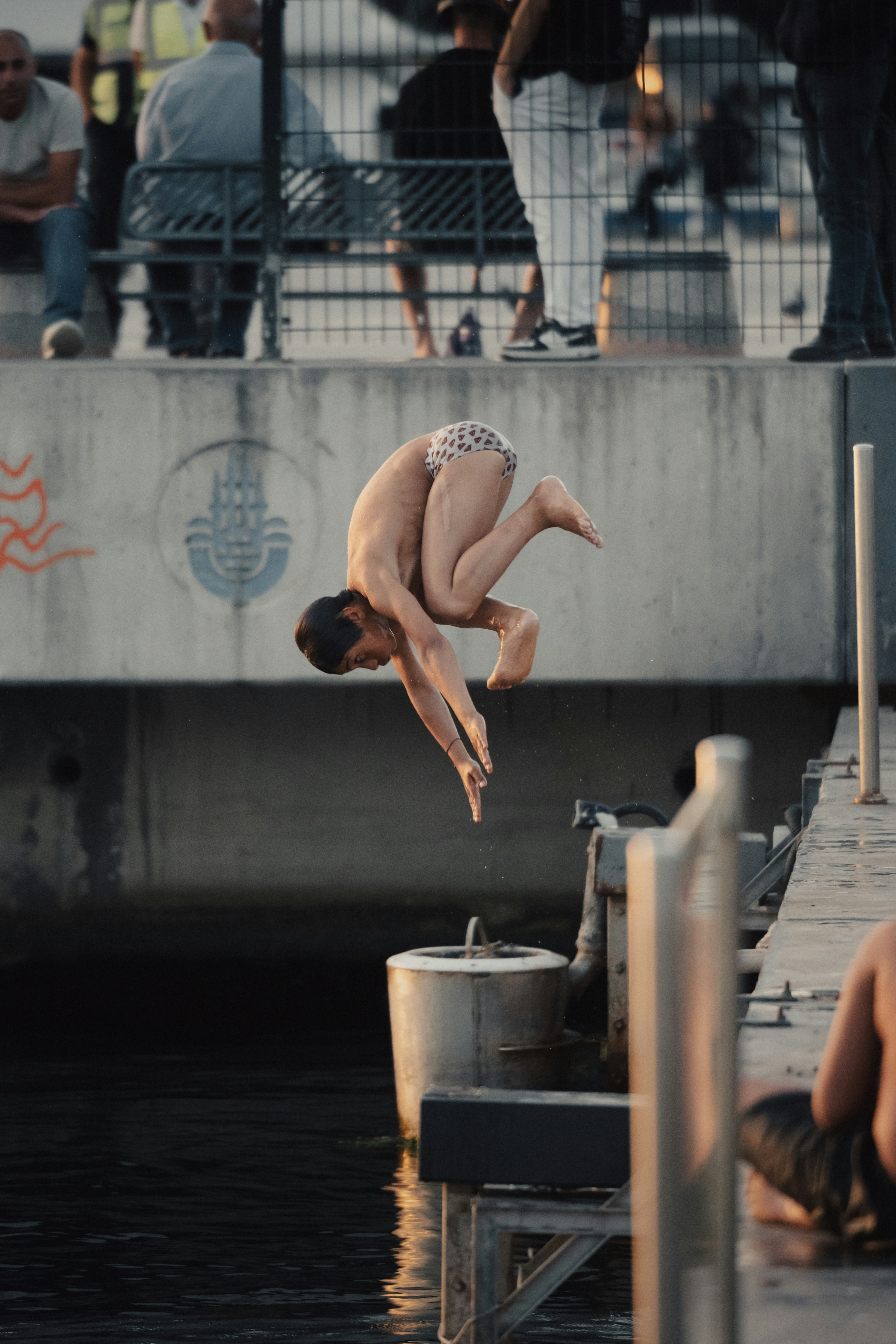 Leap of Balance: A Diver's Moment Over the Dock