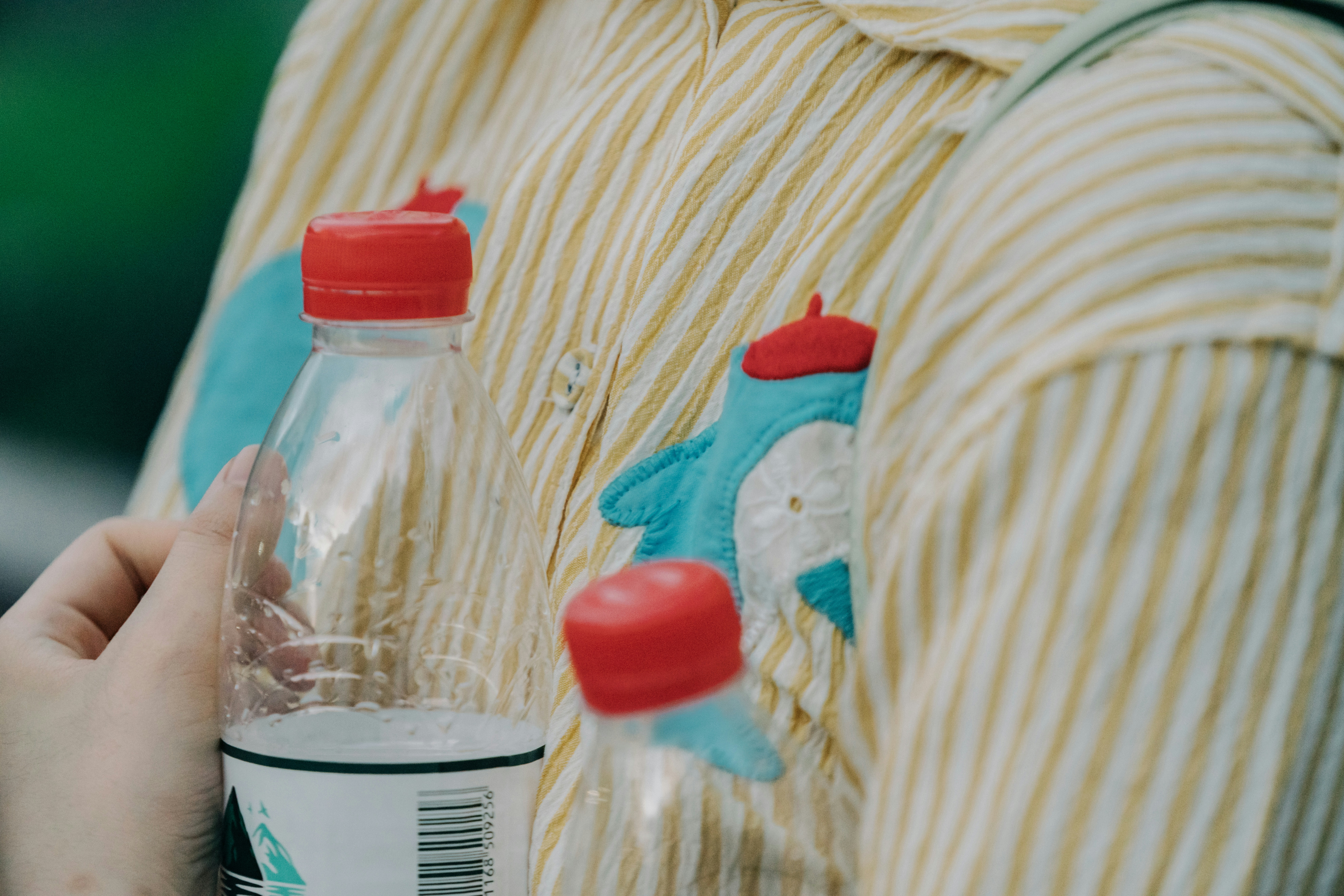 Penguin Patch Portrait: A Striped Jacket with a Red-Capped Bottle