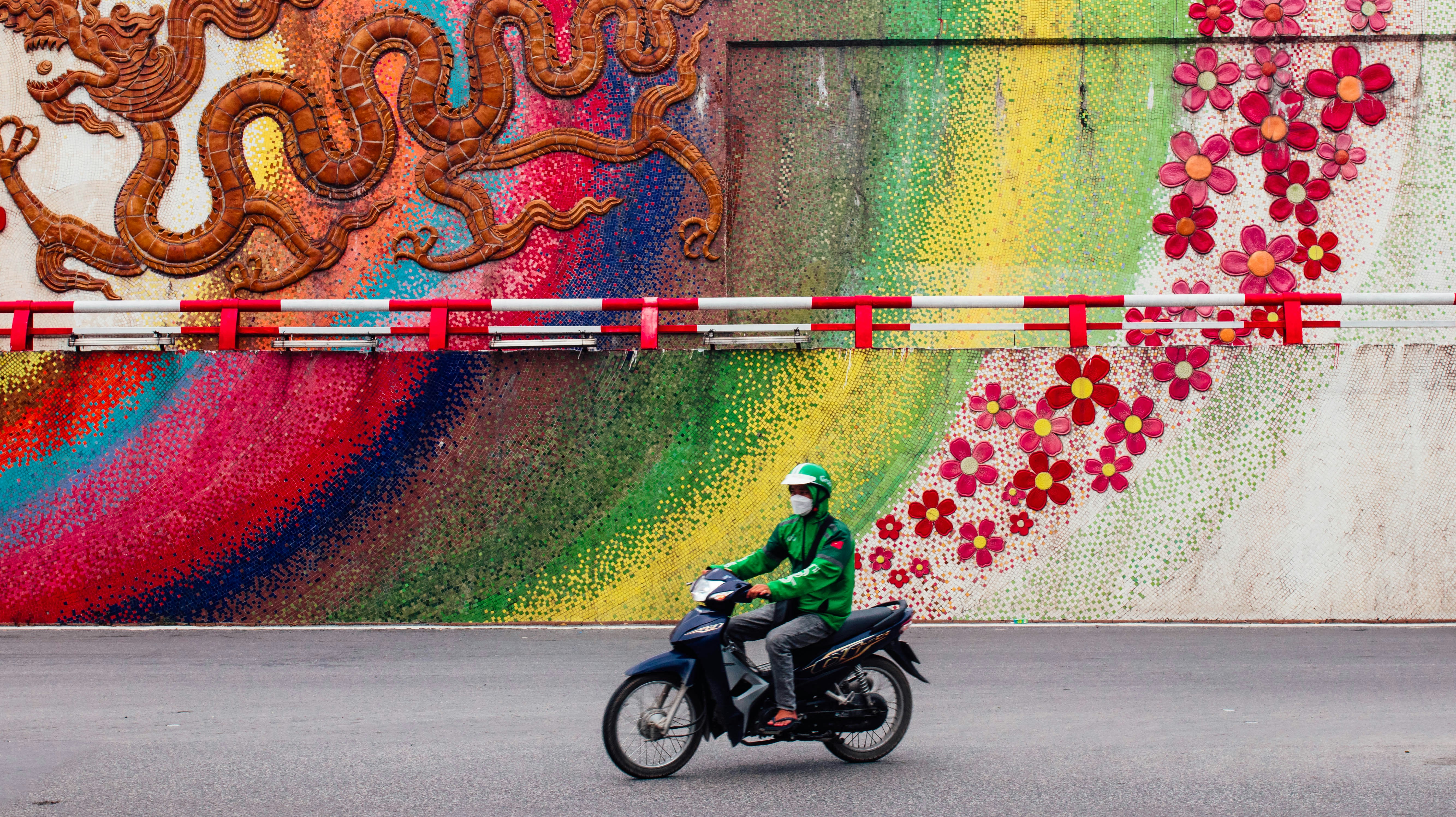Green-Jacket Rider Against a Vibrant Graffiti Panorama