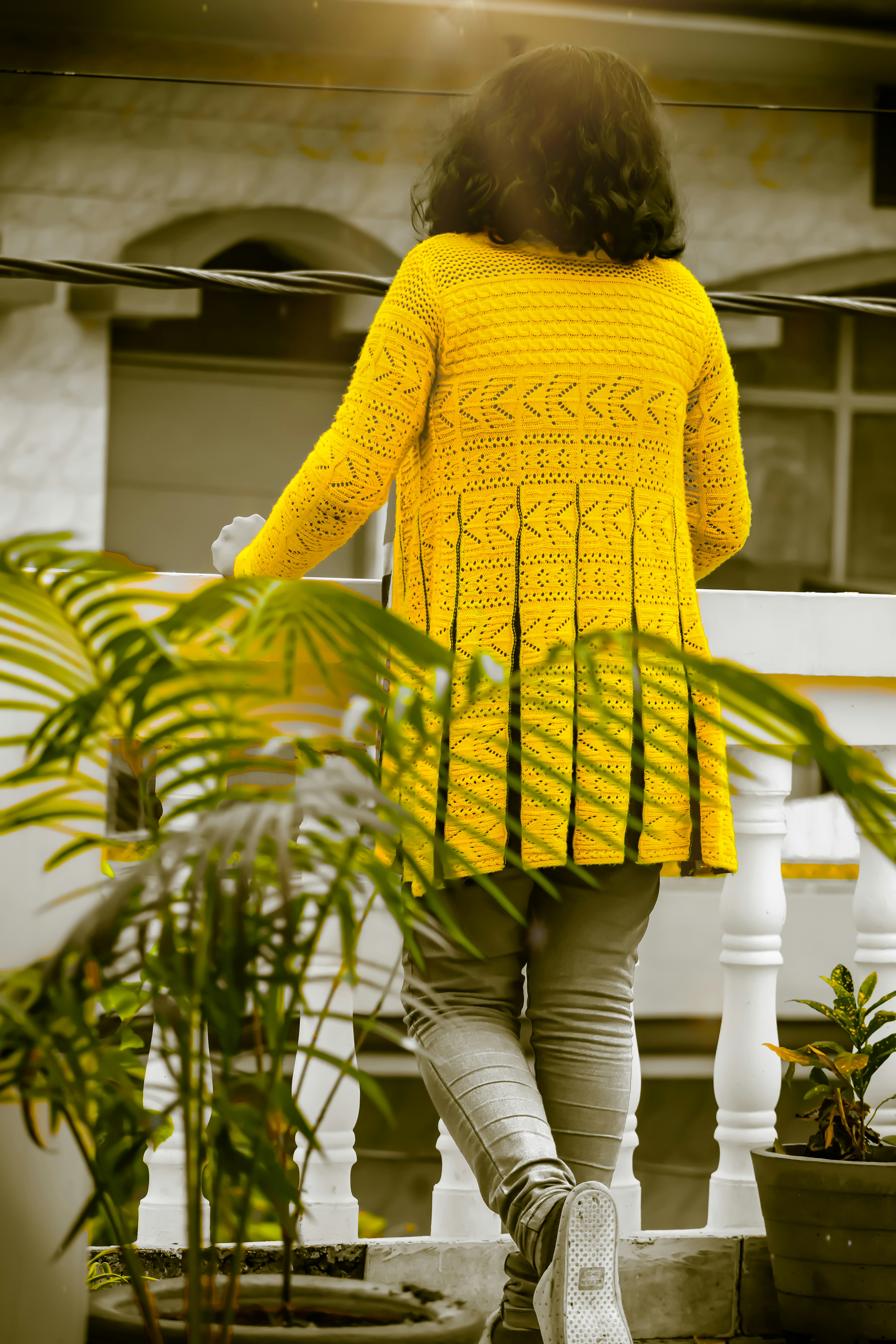 Sunlit Yellow on a Balcony: A Back‑Turn Portrait