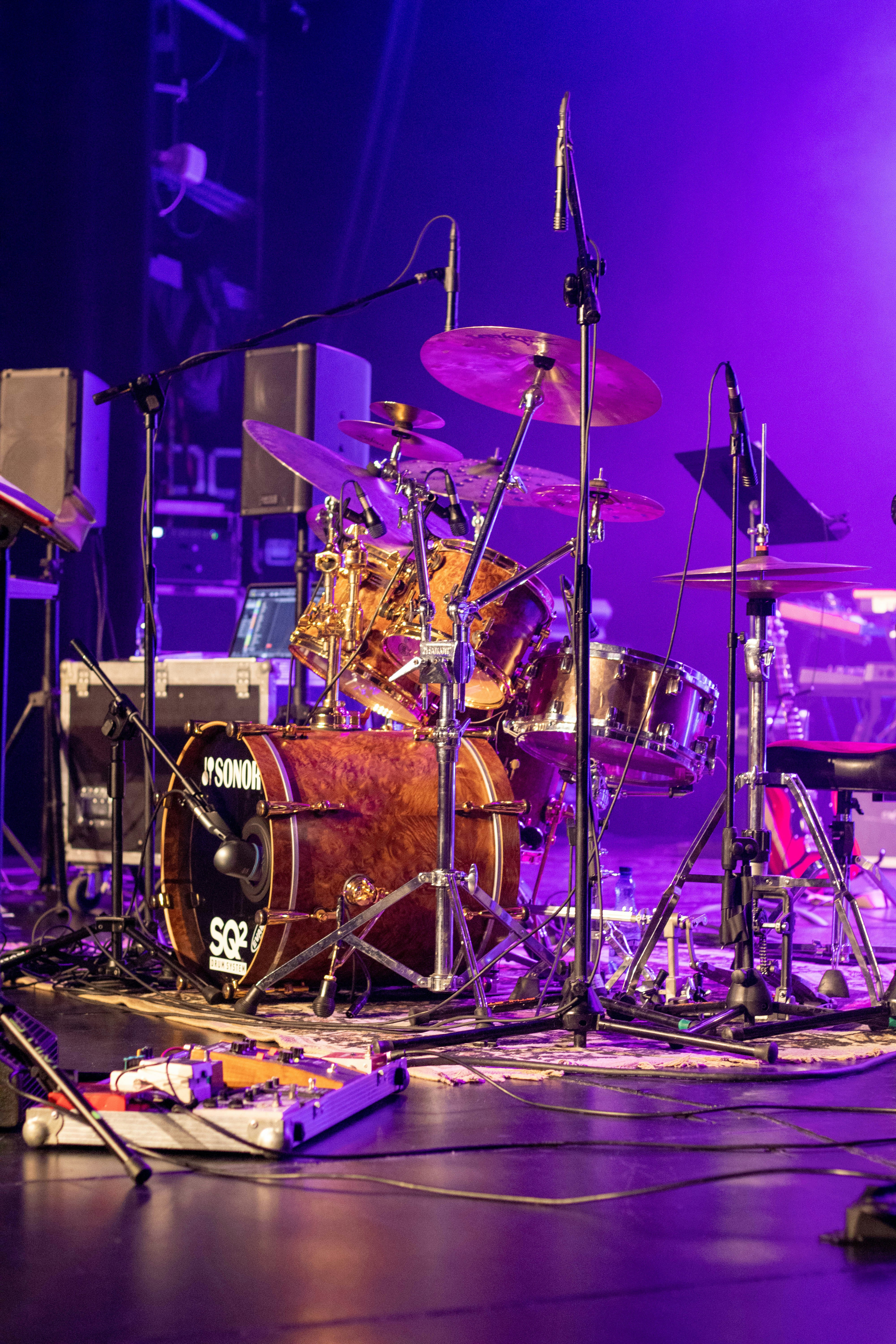 A group of musical instruments sitting on top of a stage photo – Free ...