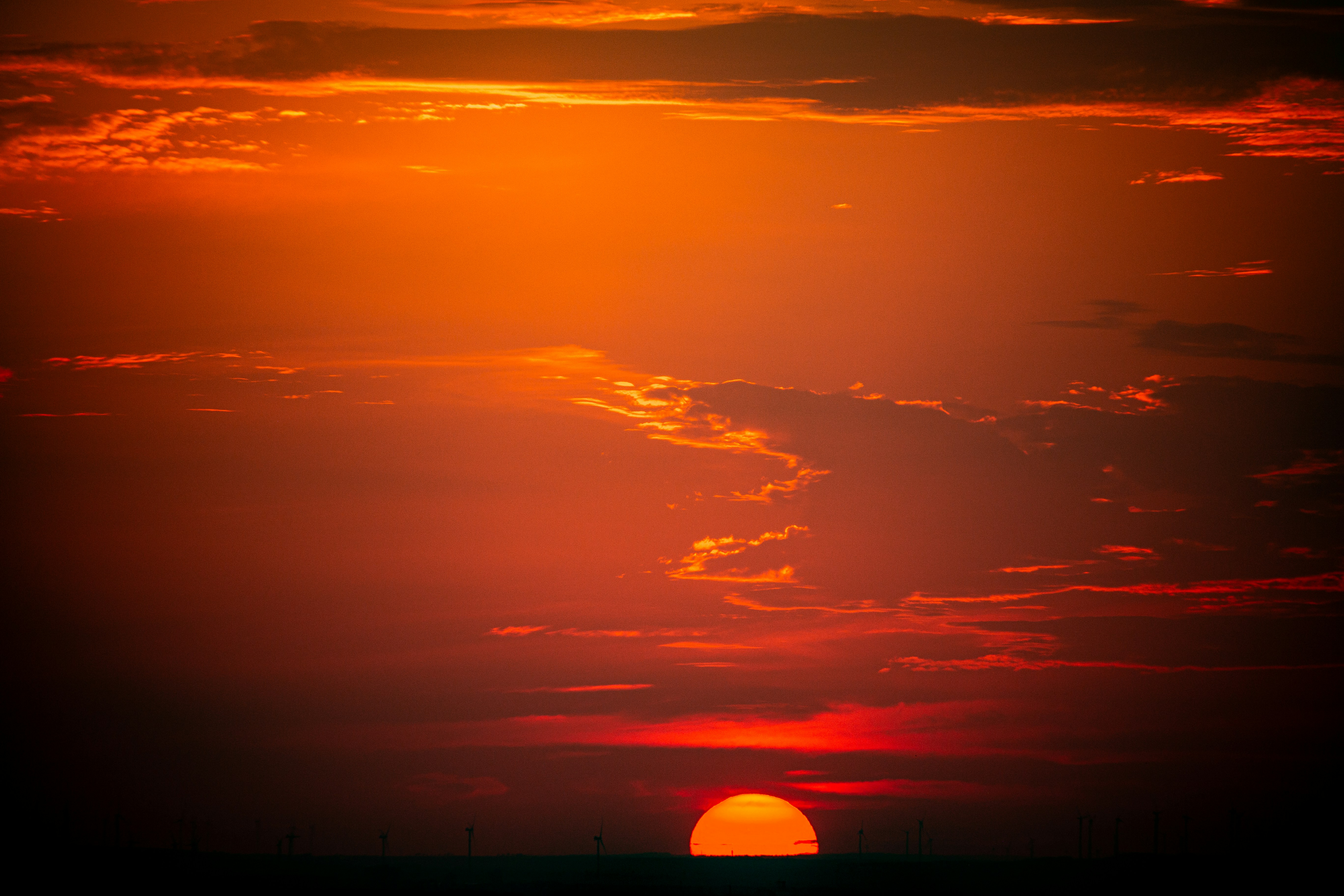 The sun is setting over the horizon of a field photo – Free Sunset ...
