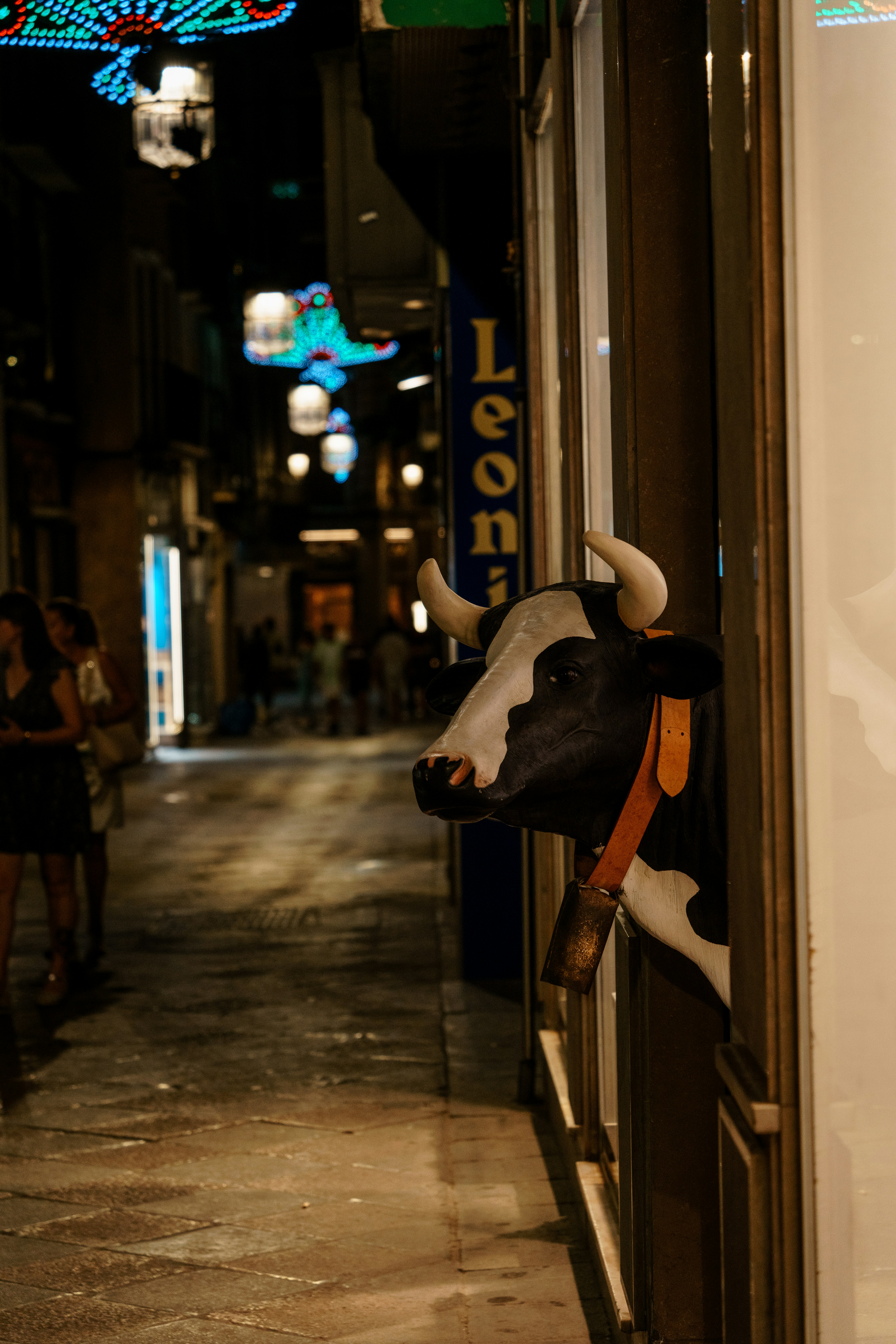 Neon Alley Cow: A Shopfront Peek in Nighttime Streets