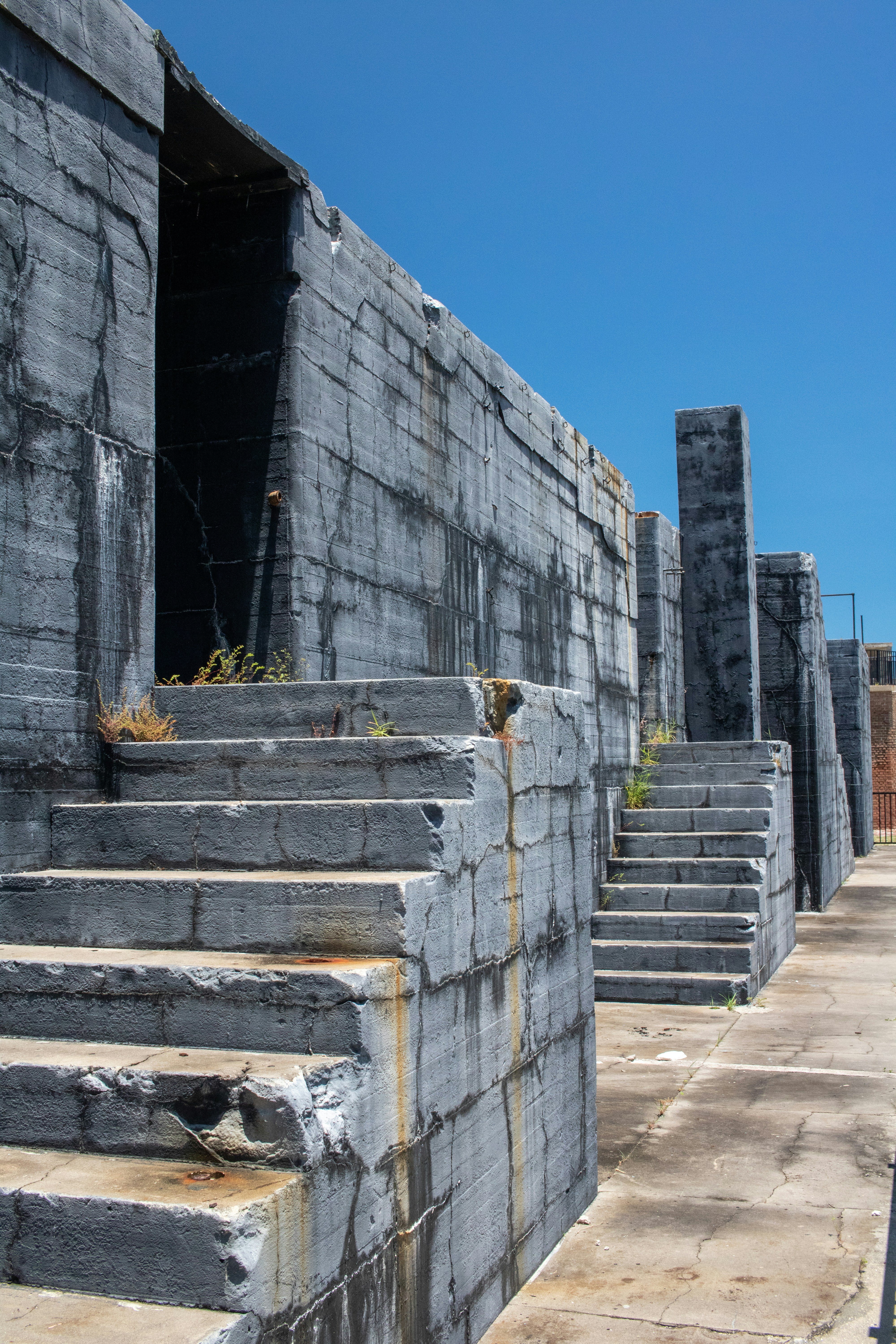 Terraced Monoliths: Weathered Concrete Ascending Toward a Bright Blue Sky