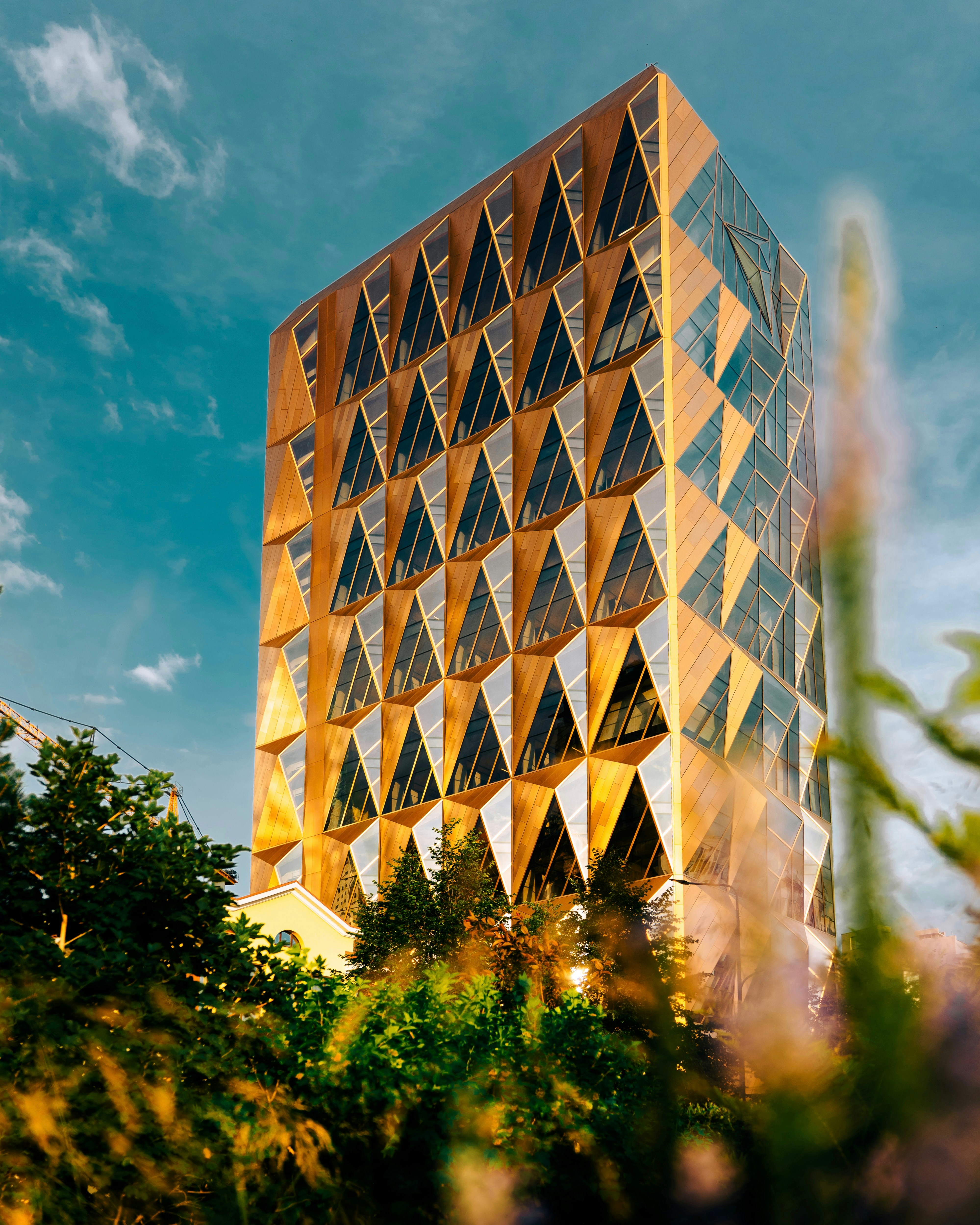 Diamond Facade Rising: A Golden Glass Tower Refracting the Morning Sky