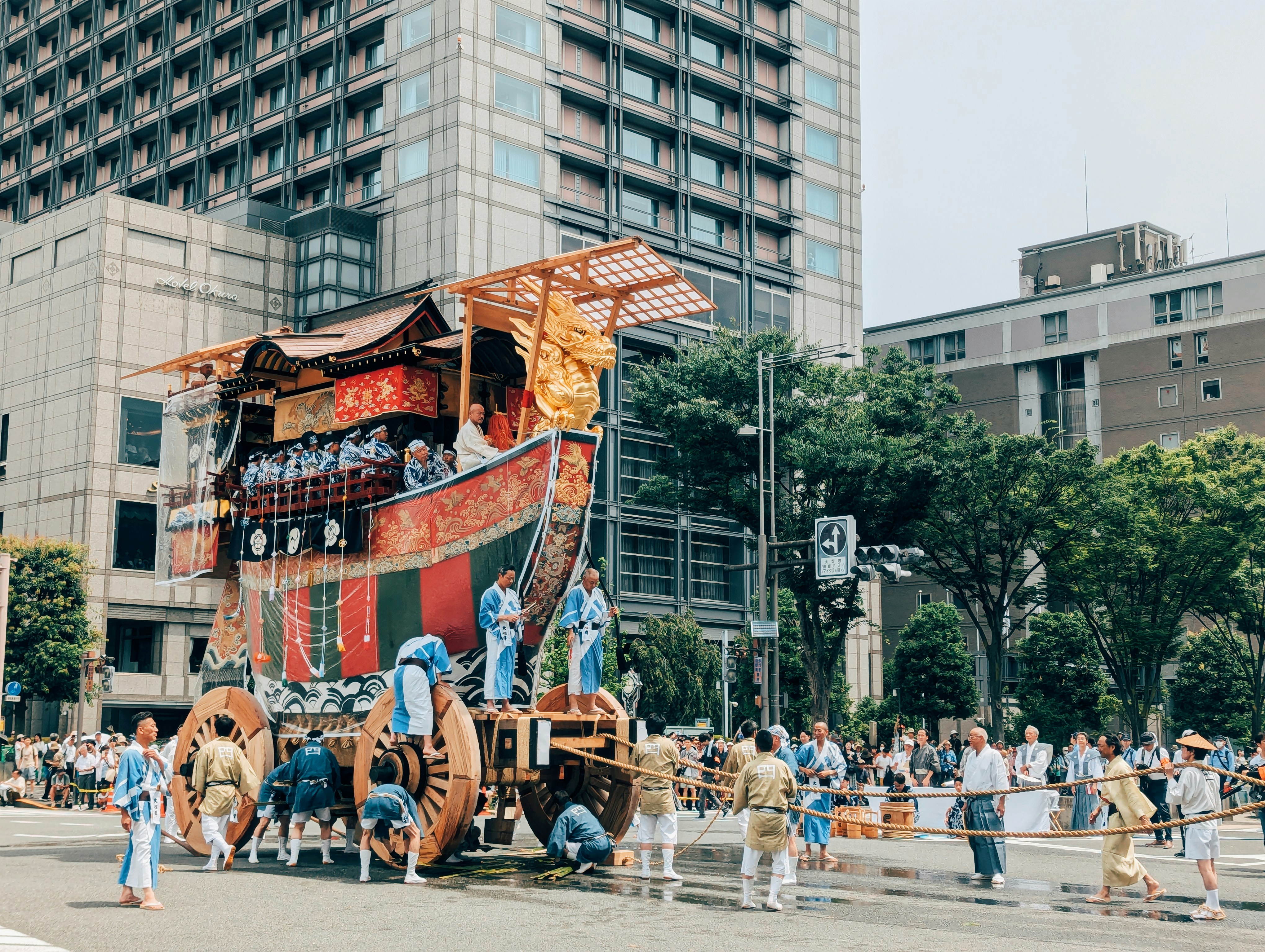 Ornate Festival Float Navigates a Modern Cityscape