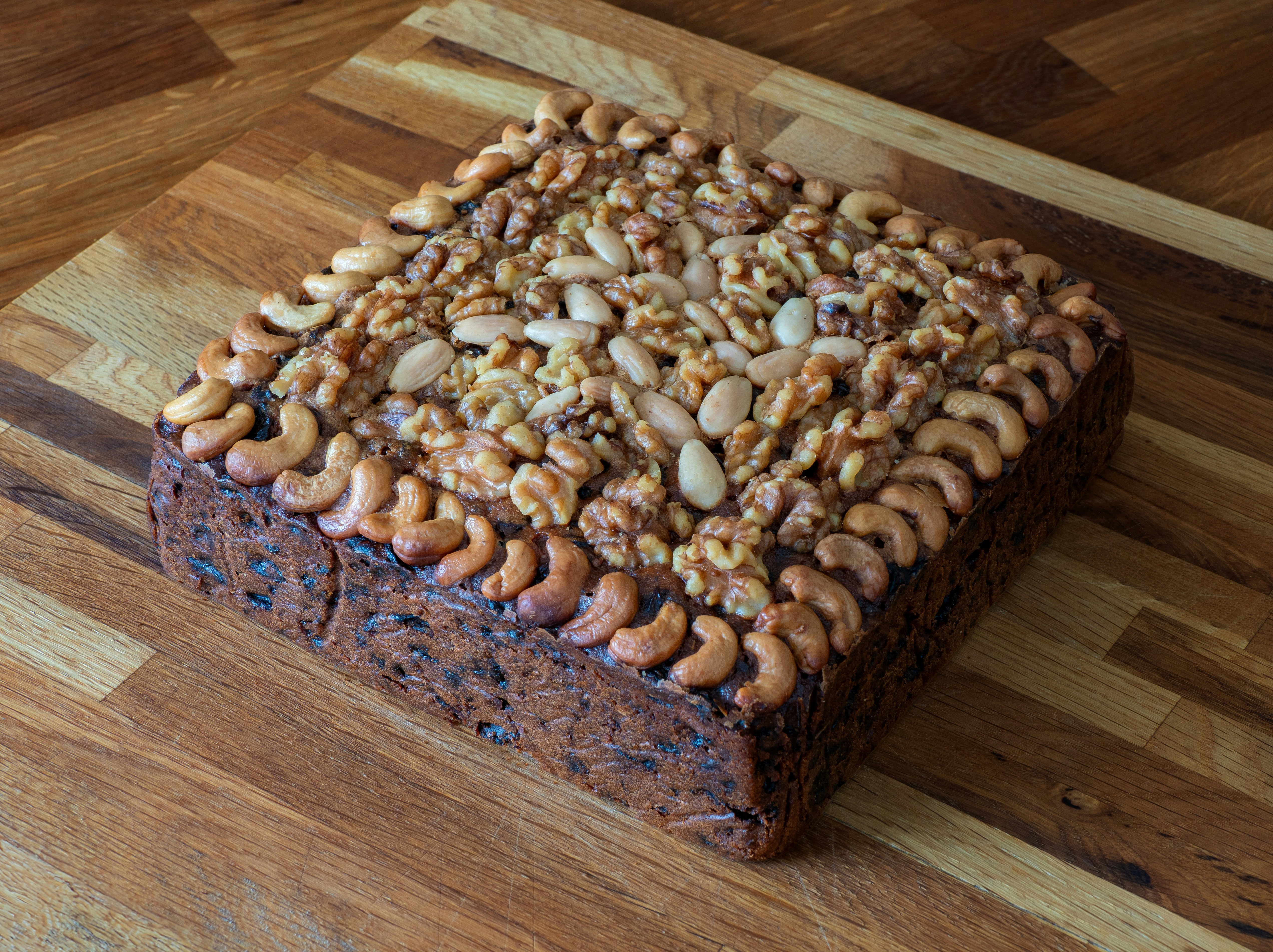 Nut-Crowned Chocolate Brownie on a Rustic Wooden Board