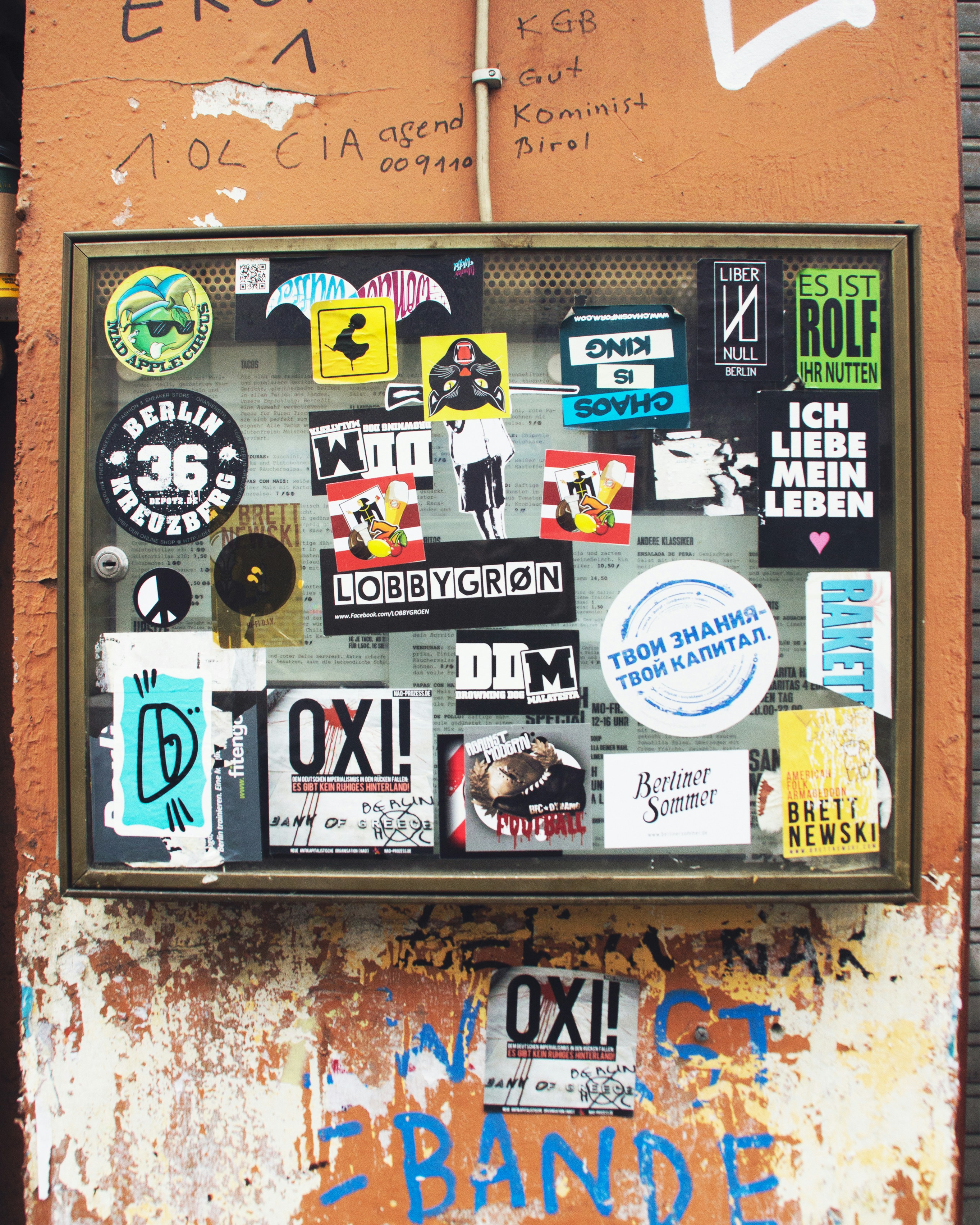 A wall with a bunch of stickers on it photo – Free Colours Image on ...