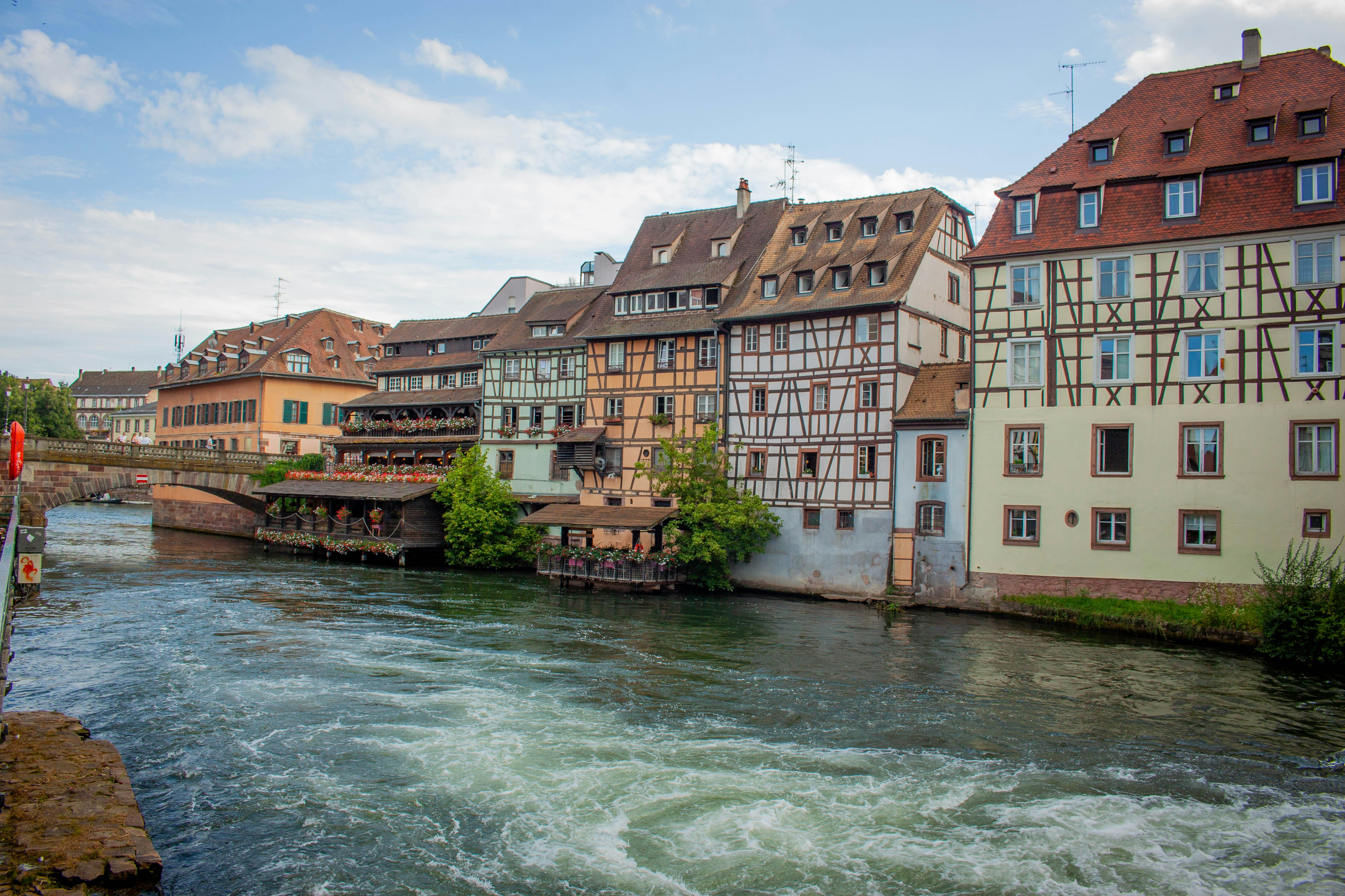 A river running through a city next to tall buildings photo – Free ...
