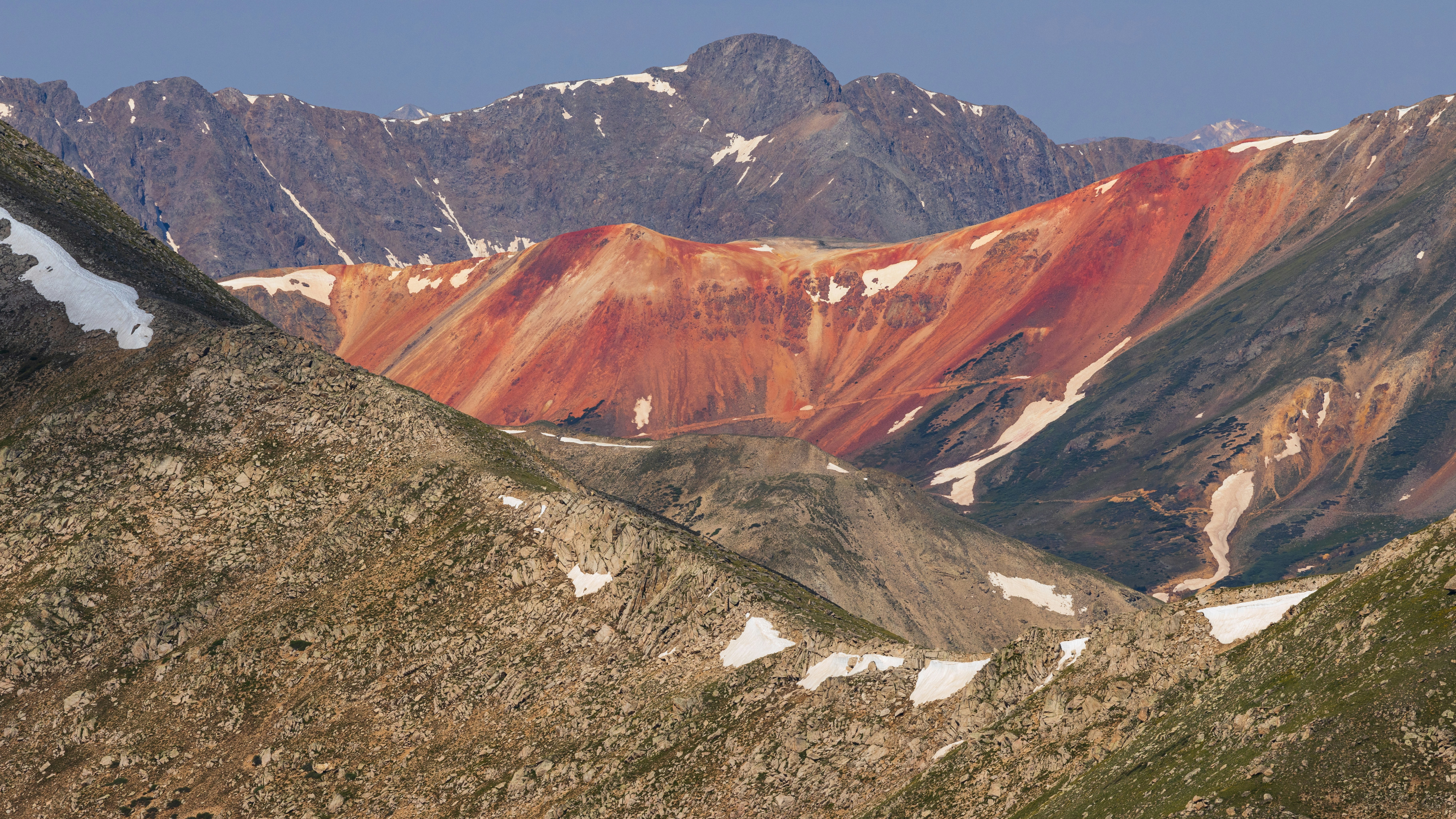 Crimson Ridges at Noon: Alpine Light on Weathered Strata