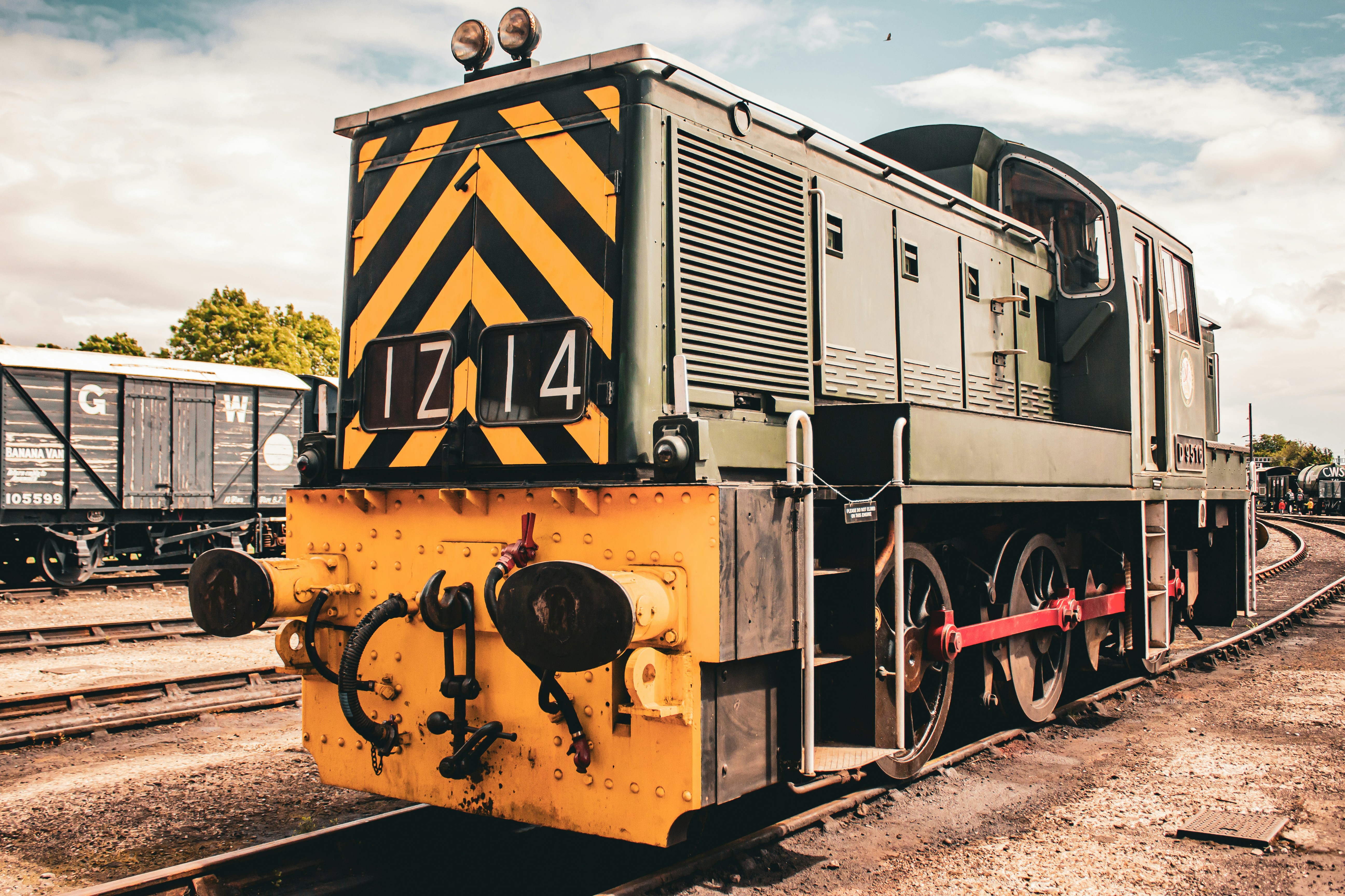 A yellow and black train engine sitting on the tracks photo – Free ...