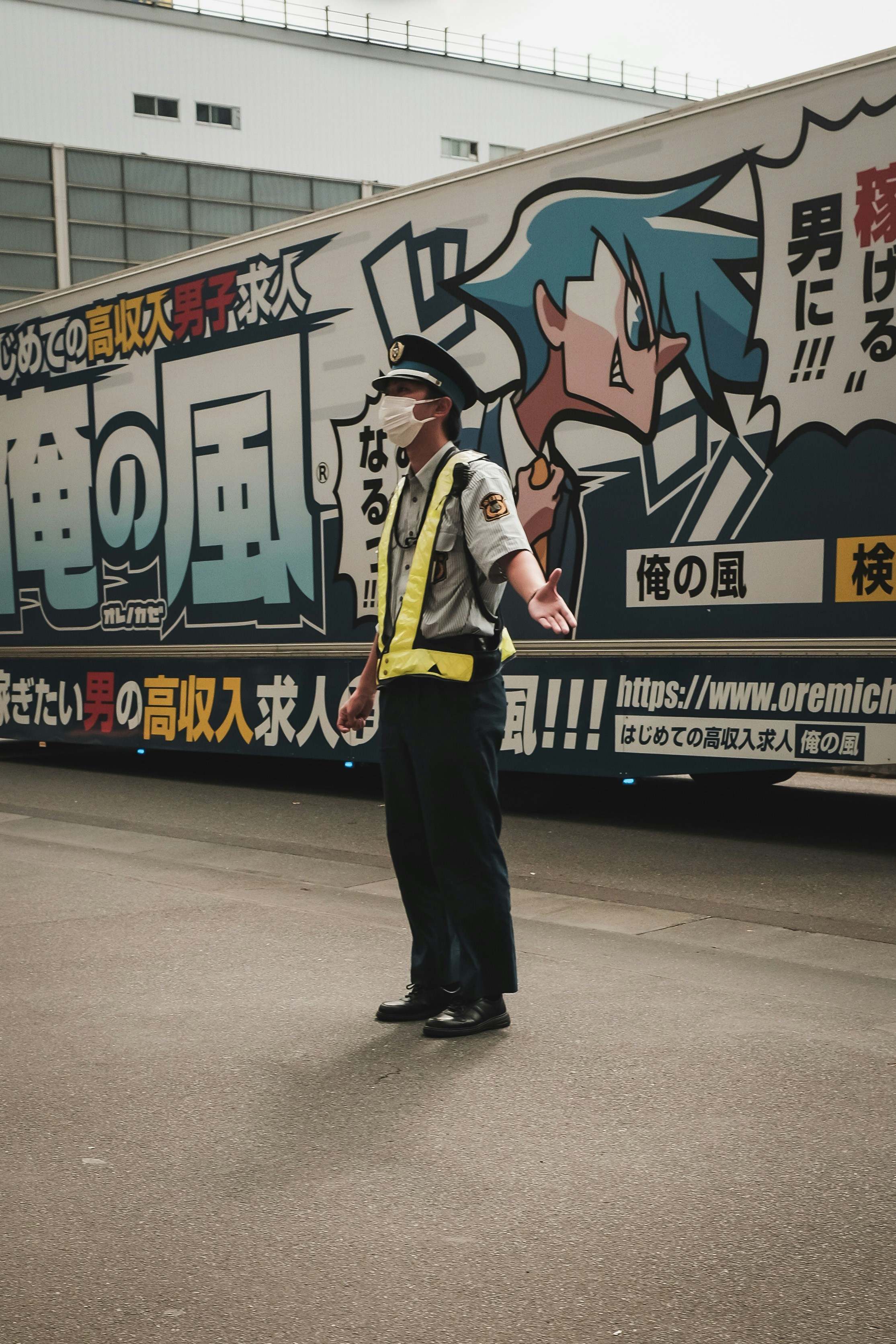 A traffic officer directing vehicles near a vividly illustrated truck featuring a cartoon character. The scene captures the blend of urban life and vibrant art.