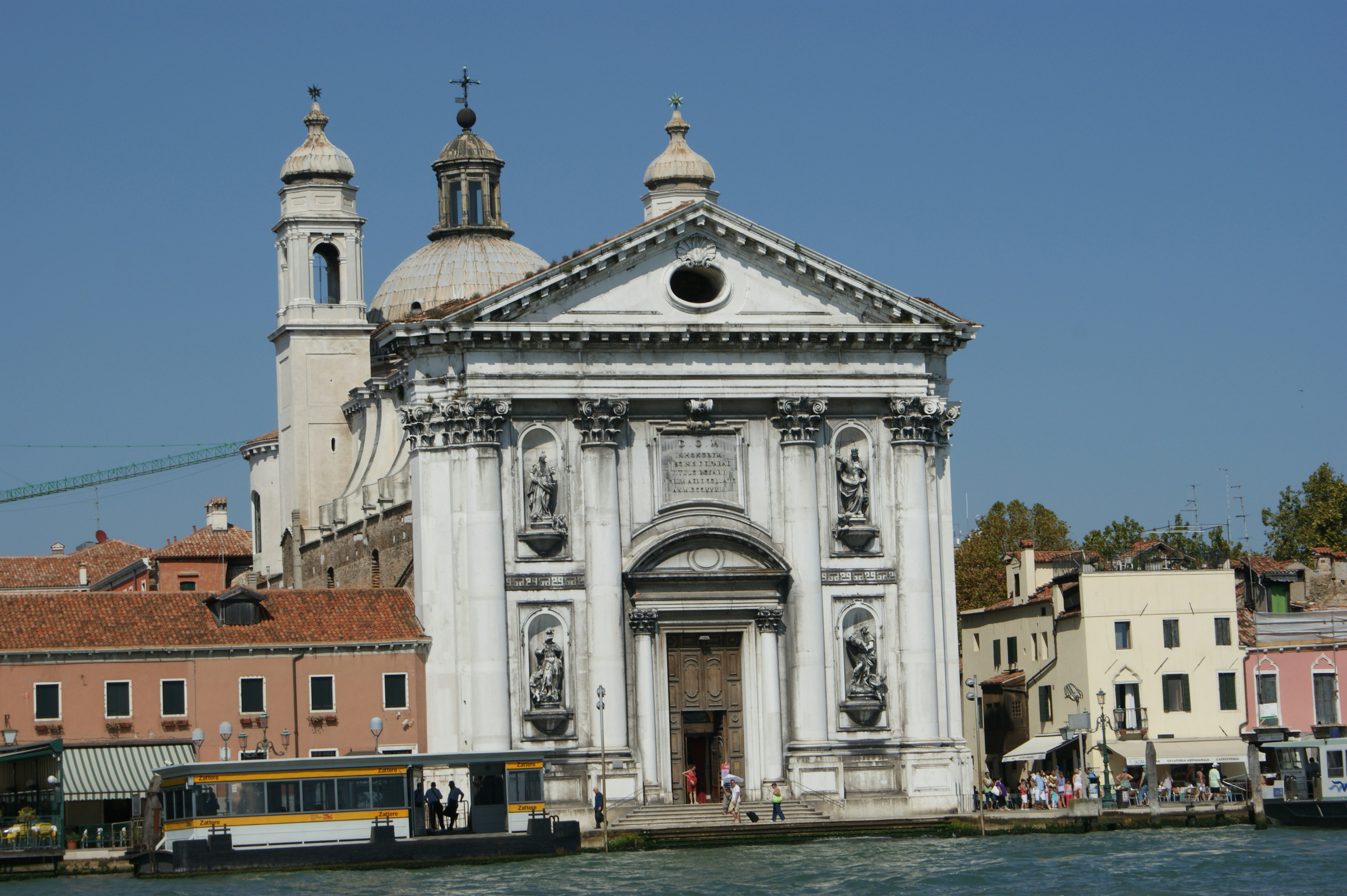 A large white building sitting next to a body of water